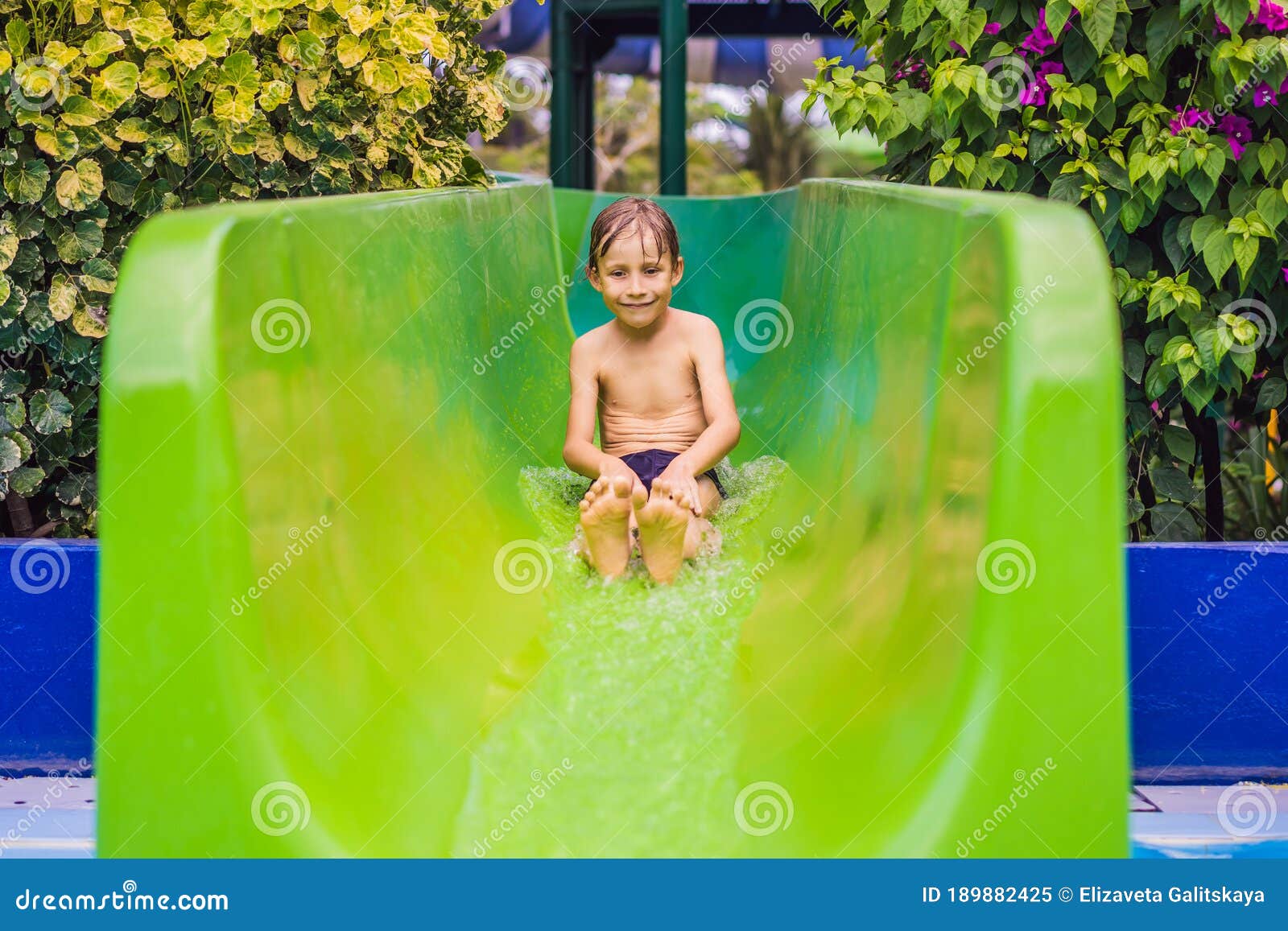 Young Boy or Kid Has Fun Splashing into Pool after Going Down Water ...