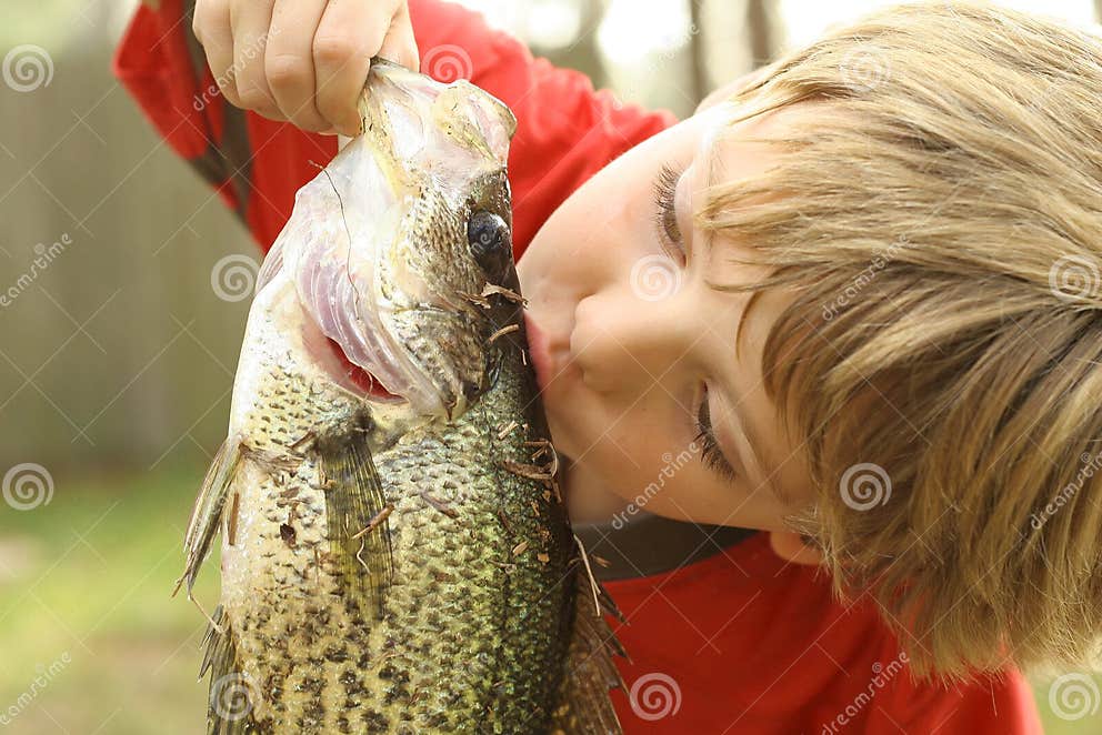 Young Boy Kissing Fish he Caught Stock Image - Image of outside, youth ...