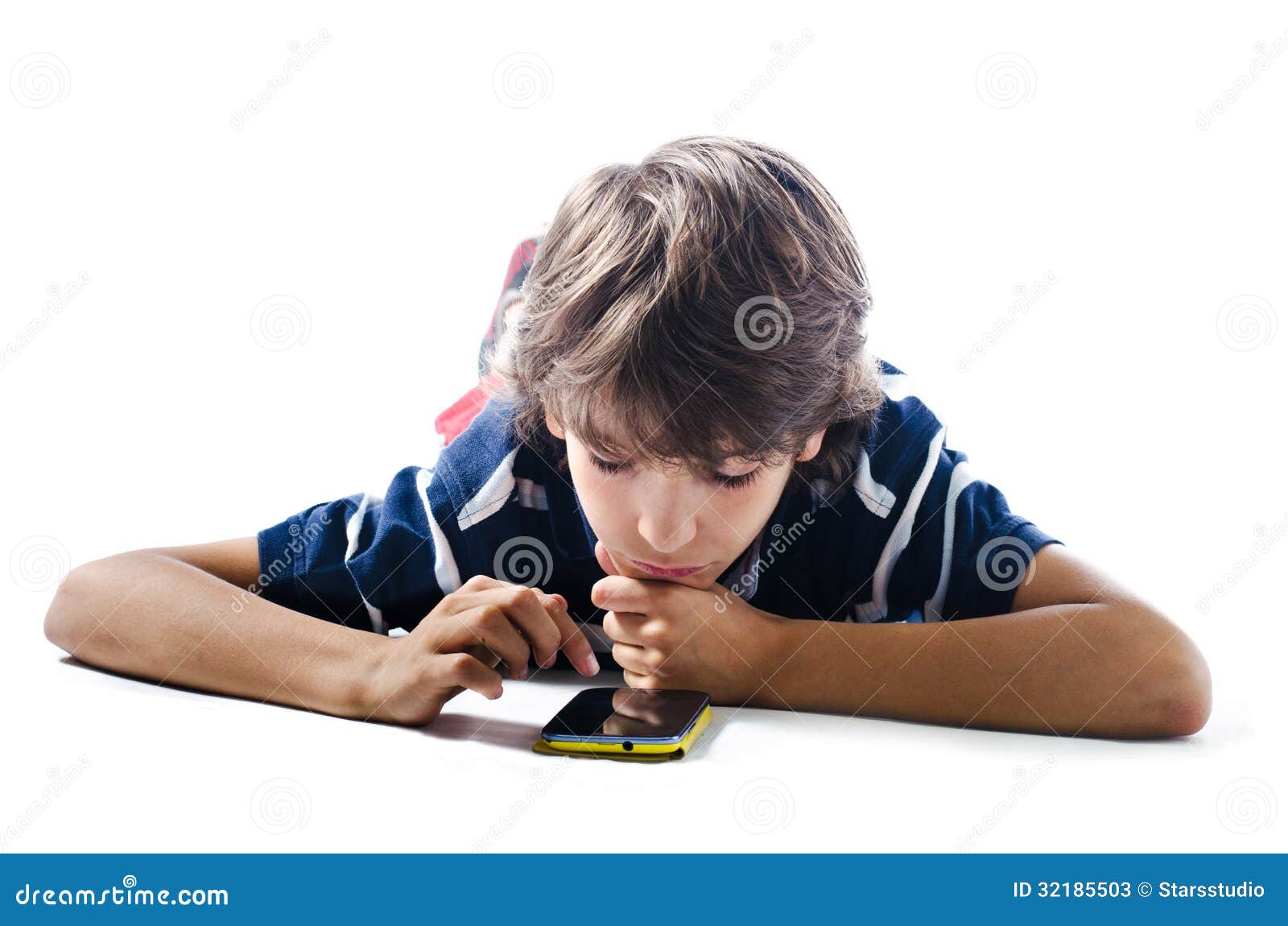 Young Boy Laying on the Floor Using Cell Phone Stock Image - Image of ...