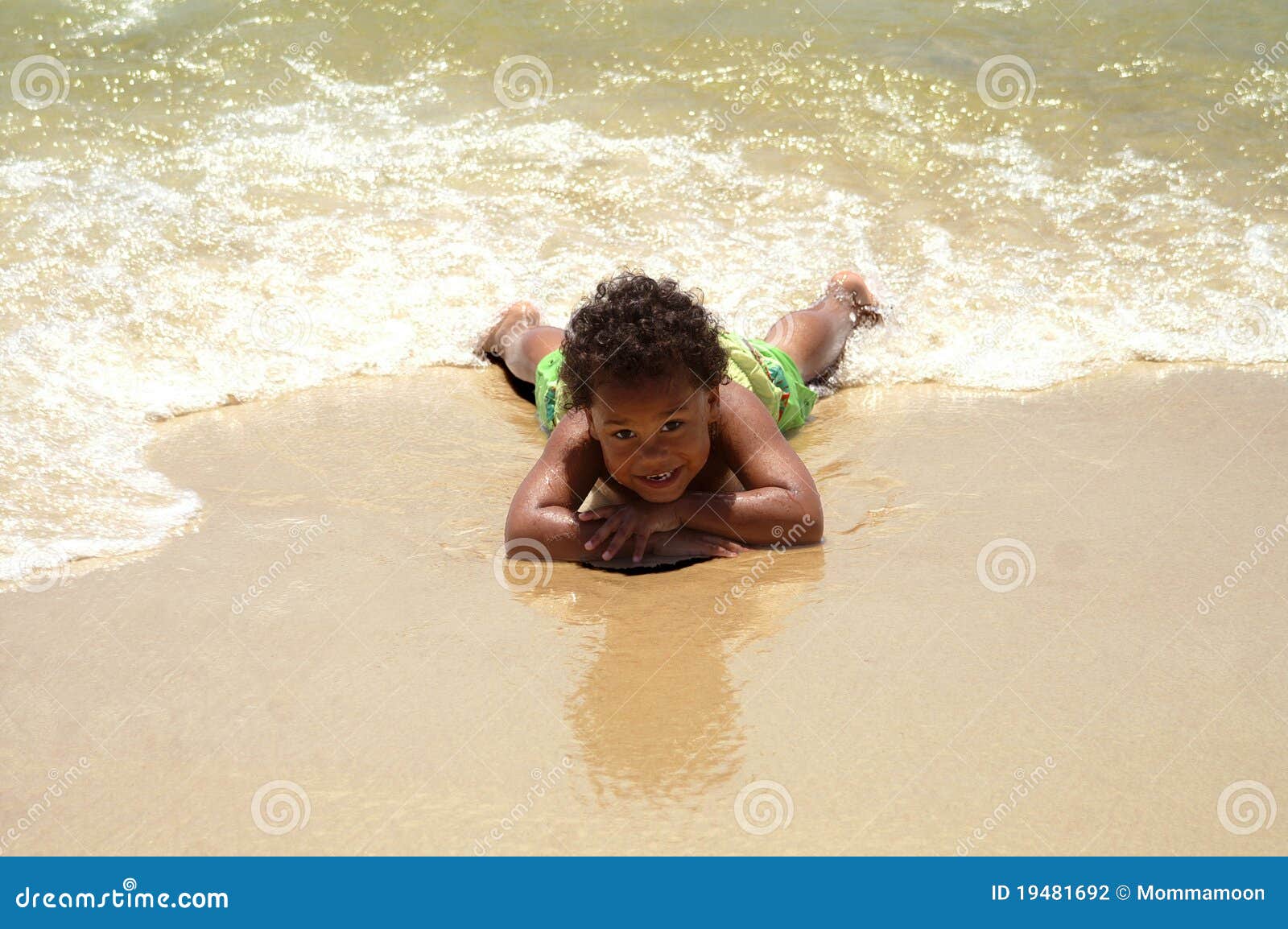 Young Boy Laying on Sand stock photo. Image of spring - 19481692