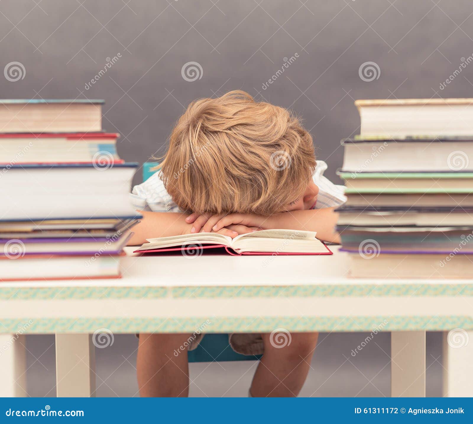 Young Boy Leaning on a Table Full of Books Stock Photo - Image of focus ...