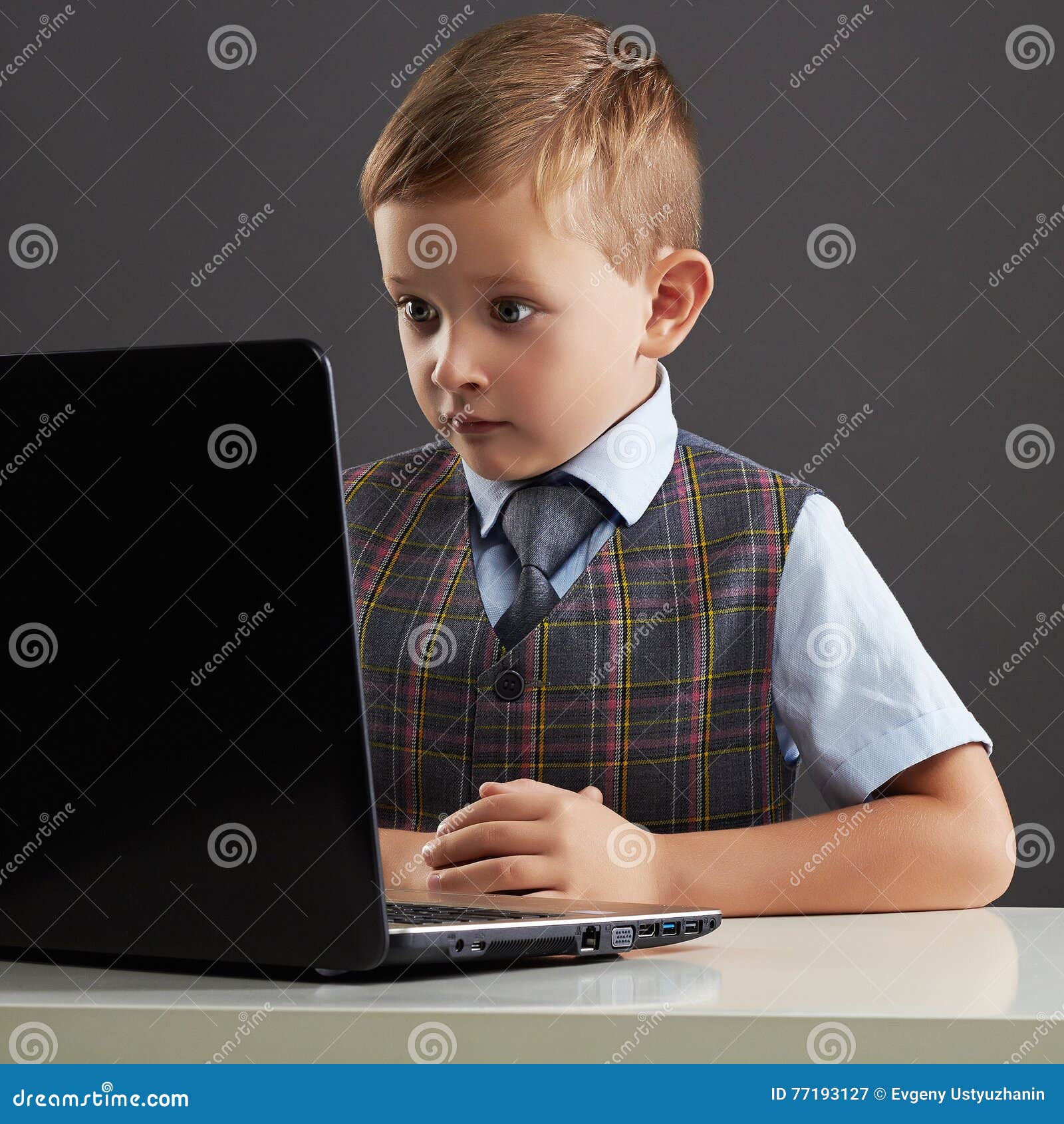 Young Boy Looking in the Notebook Screen. Funny Child with Computer ...