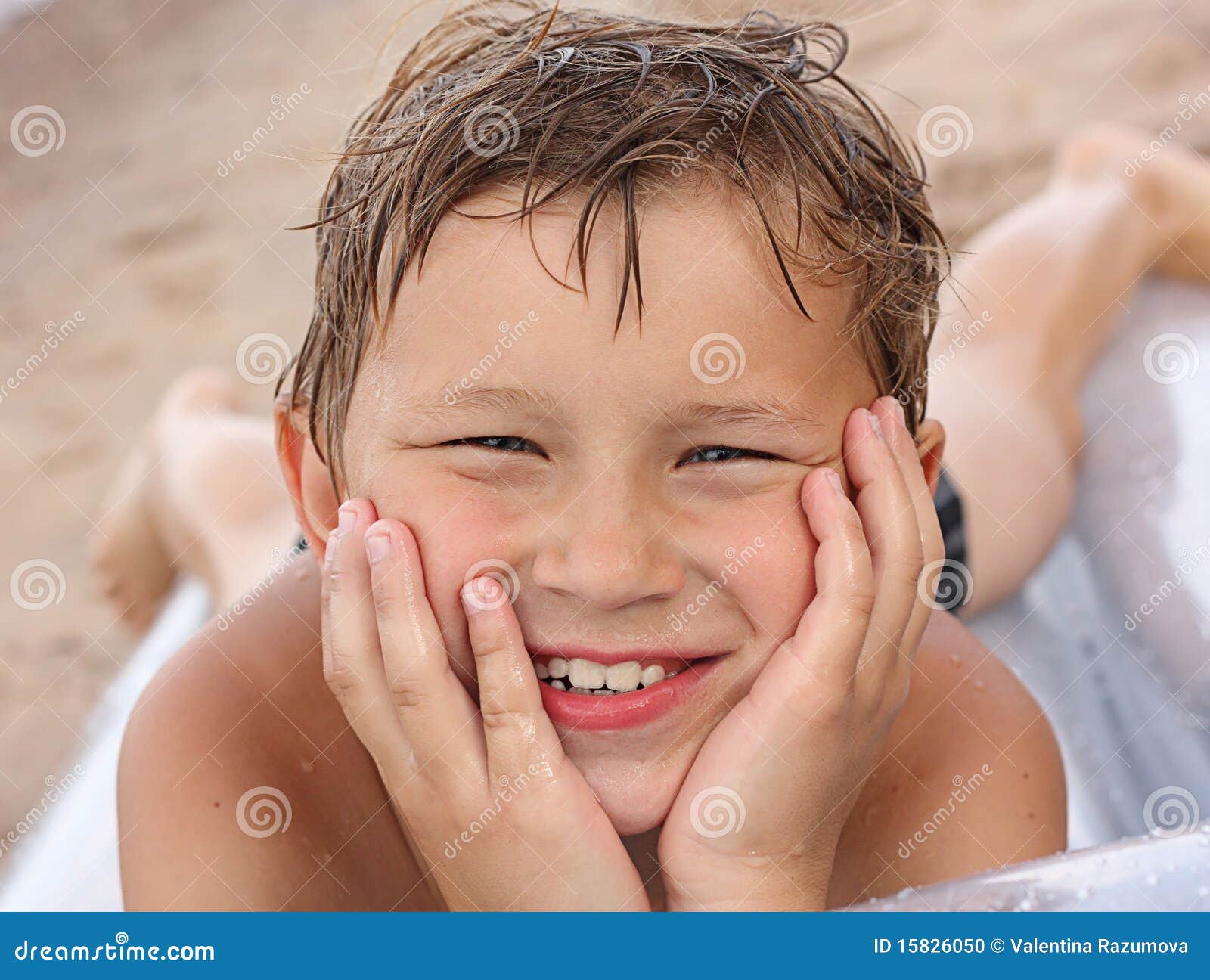 Young Boy Lying on the Beach Stock Photo - Image of happy, portrait ...