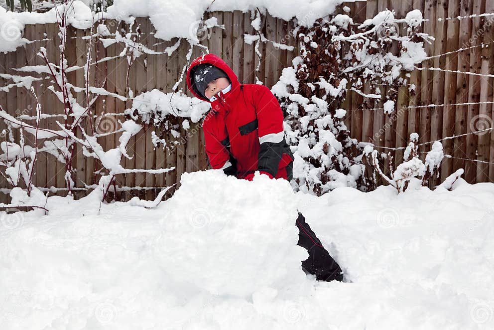 Young boy making a snowman stock photo. Image of people - 17213358