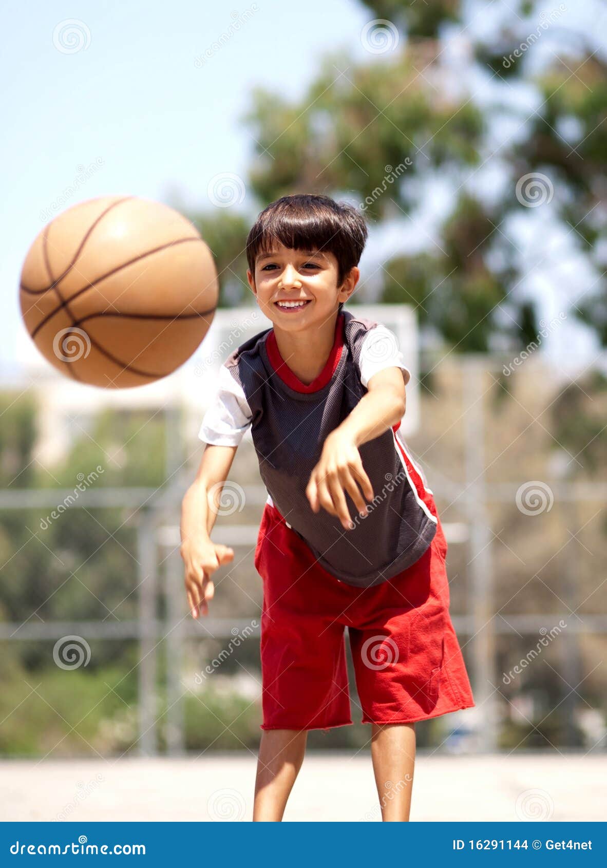 Young Boy Passing Basketball Stock Photo - Image of looking, action ...