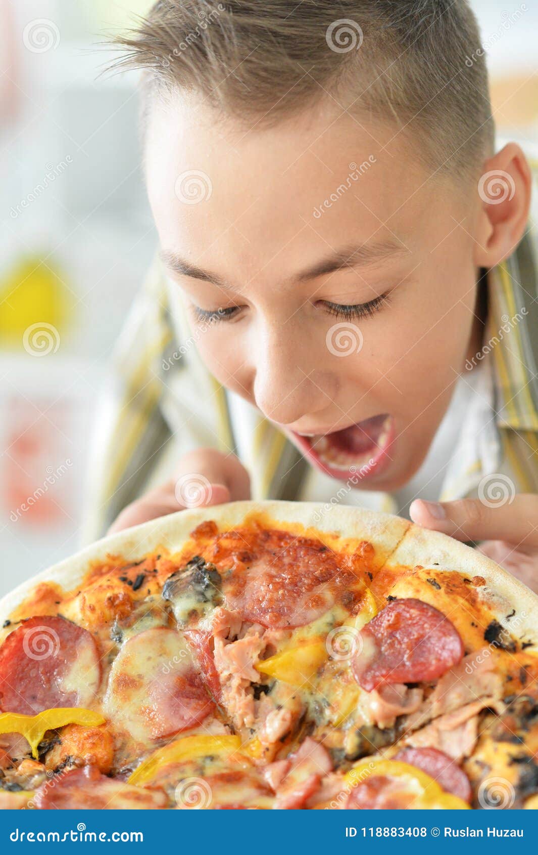 Young boy with pizza stock photo. Image of pleasure - 118883408
