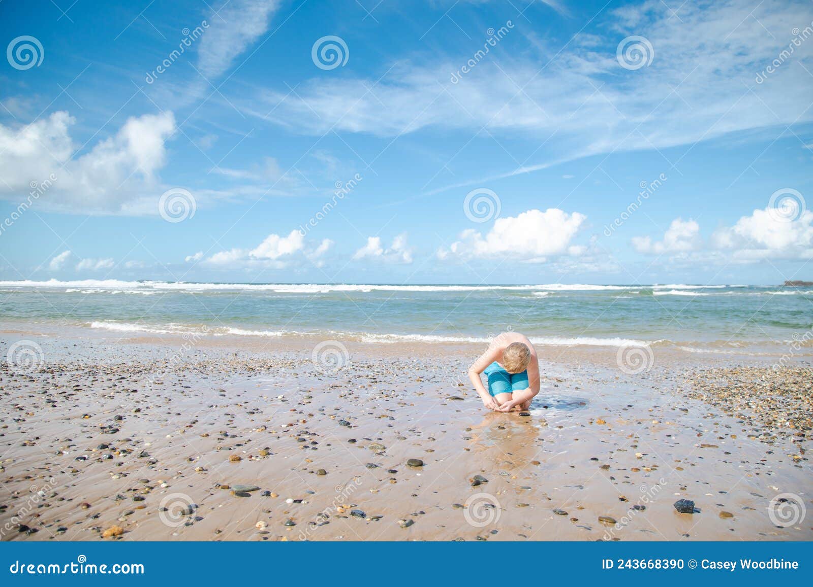 Young Boy Playing on the Beach Digging in the Sand on a Summer Day ...