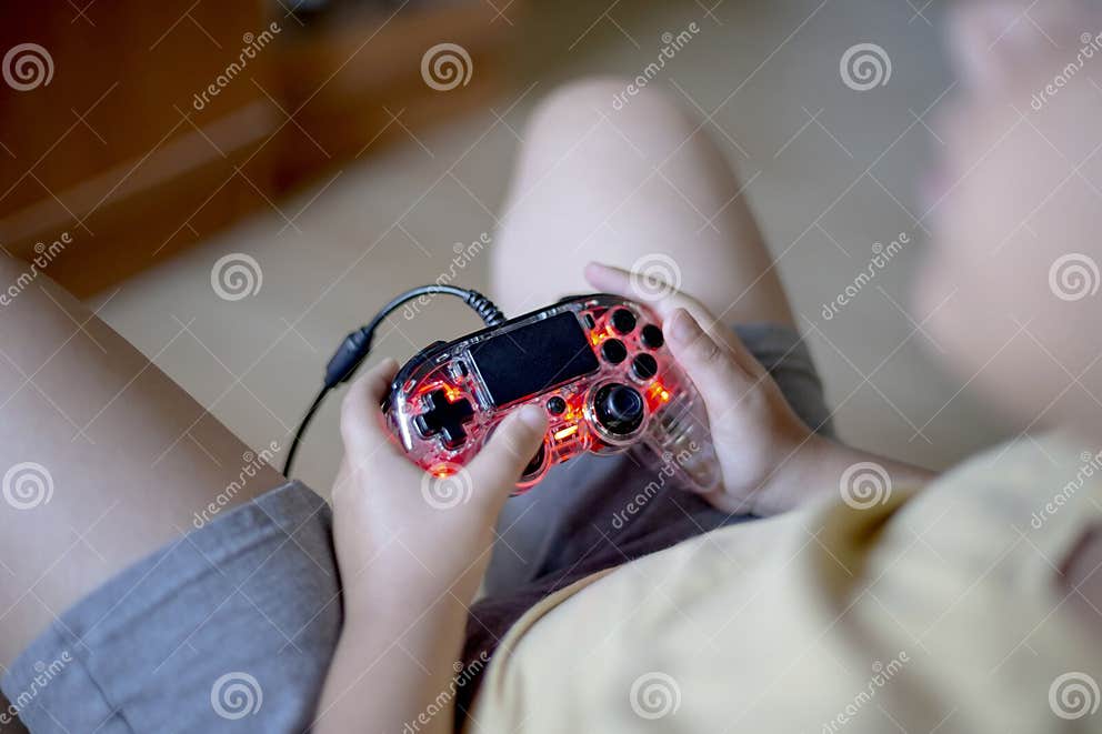 Young Boy Playing a Console Game Sitting on a Pouffe Stock Image ...