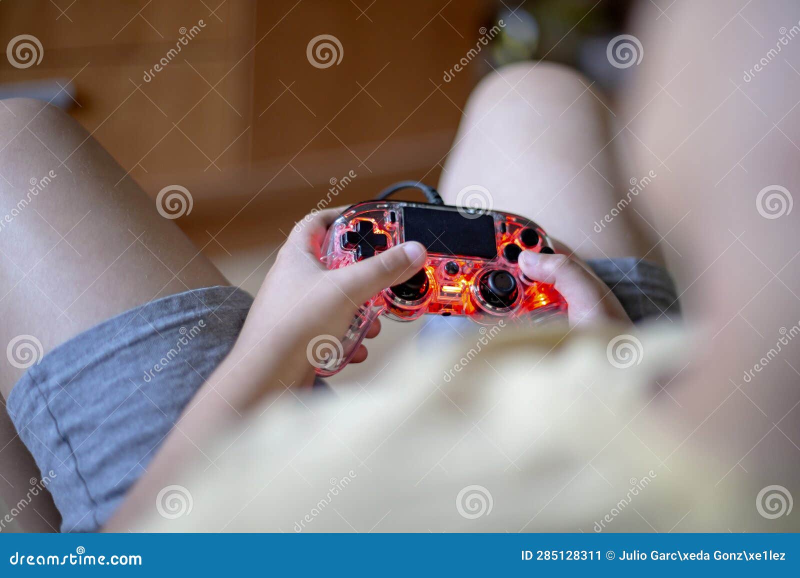 Young Boy Playing a Console Game Sitting on a Pouffe Stock Image ...