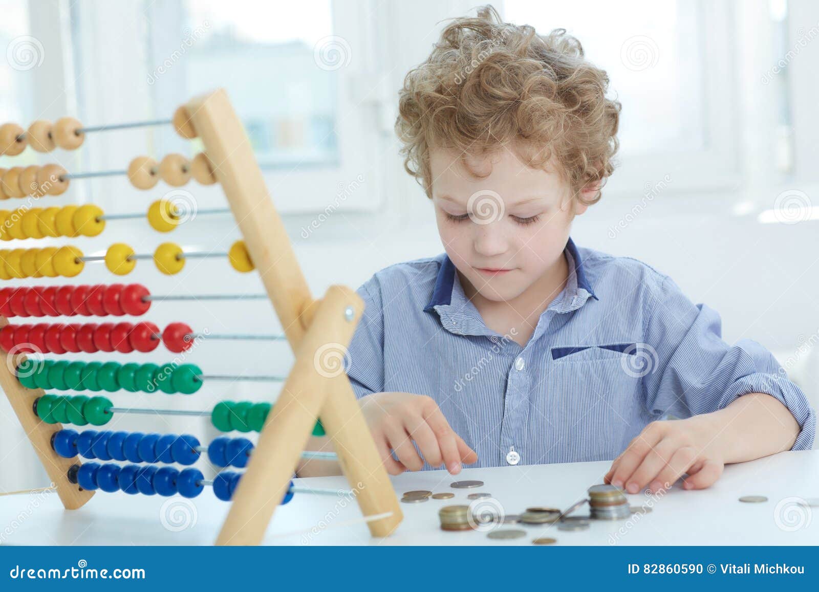 Young Caucasian Curly Boy Playing with Counter and Coins. Stock Photo ...