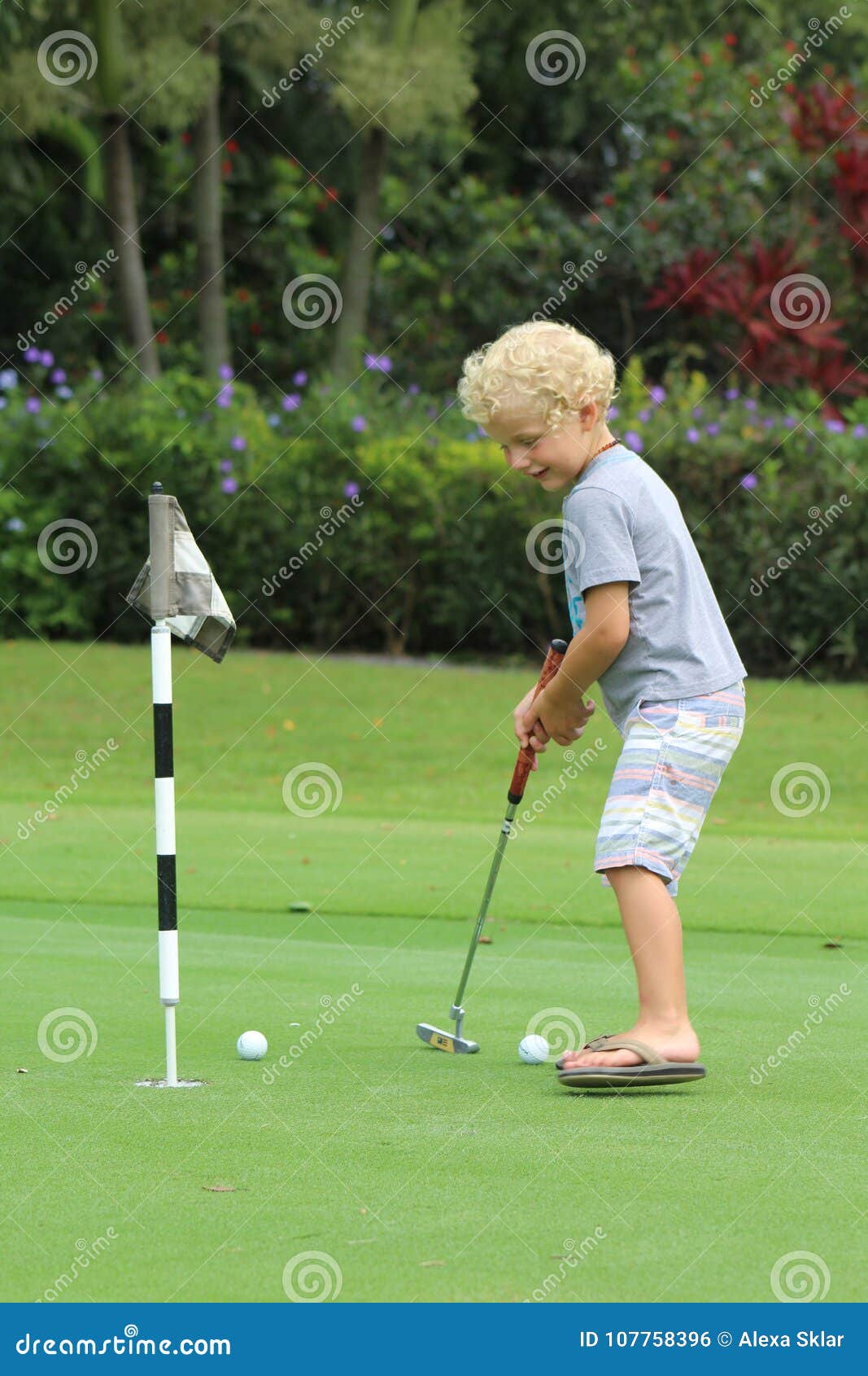 Young boy playing golf stock photo. Image of active - 107758396