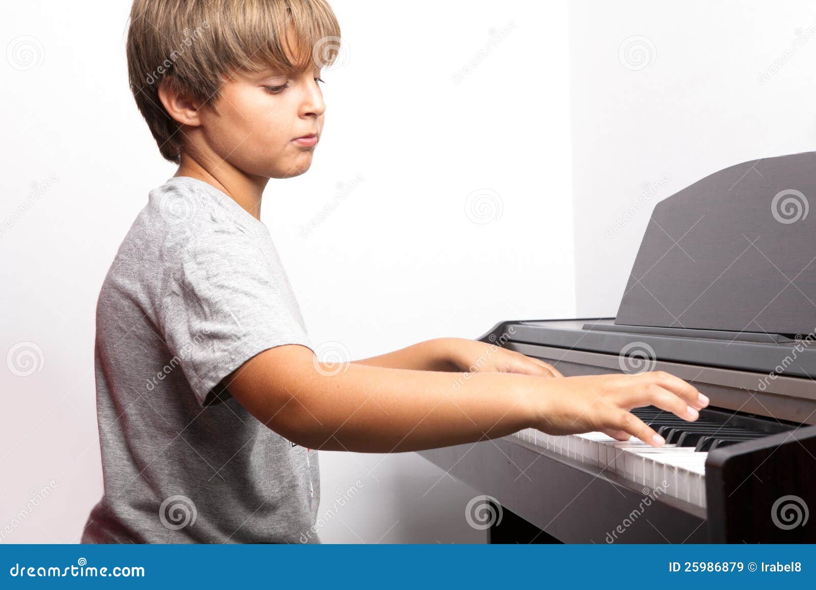 Young boy playing piano stock image. Image of handsome - 25986879