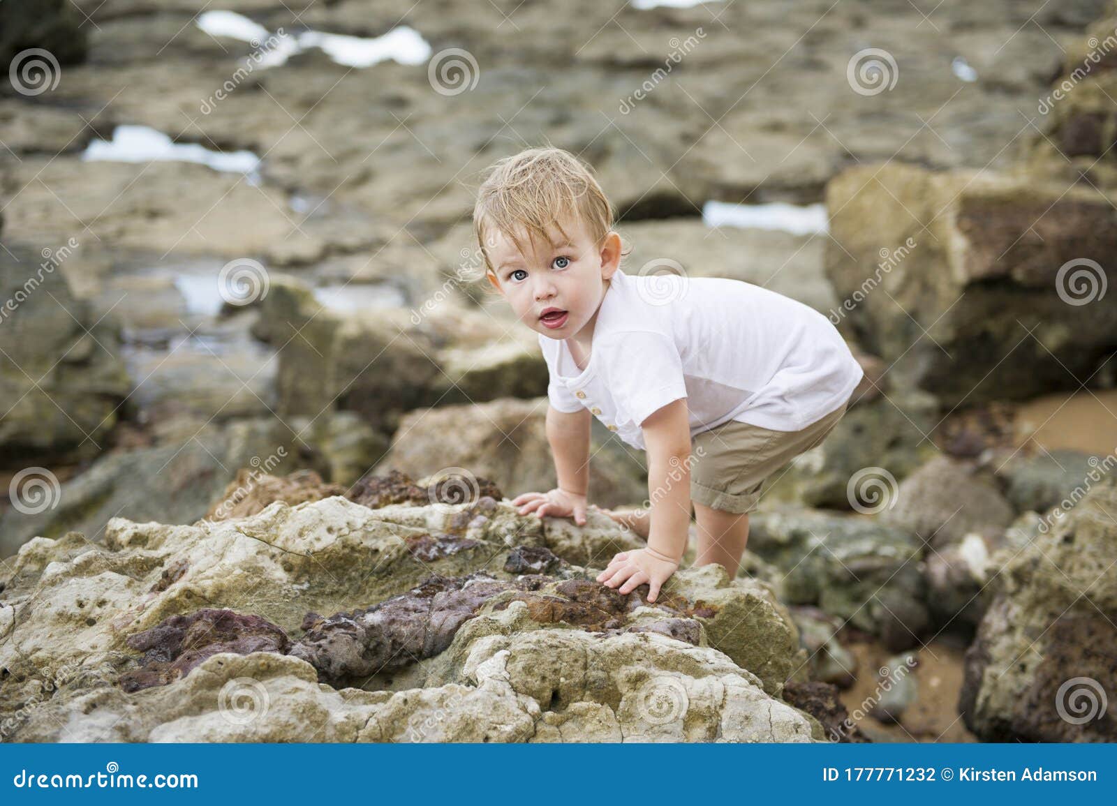 Young boy playing on rocks stock photo. Image of earth - 177771232