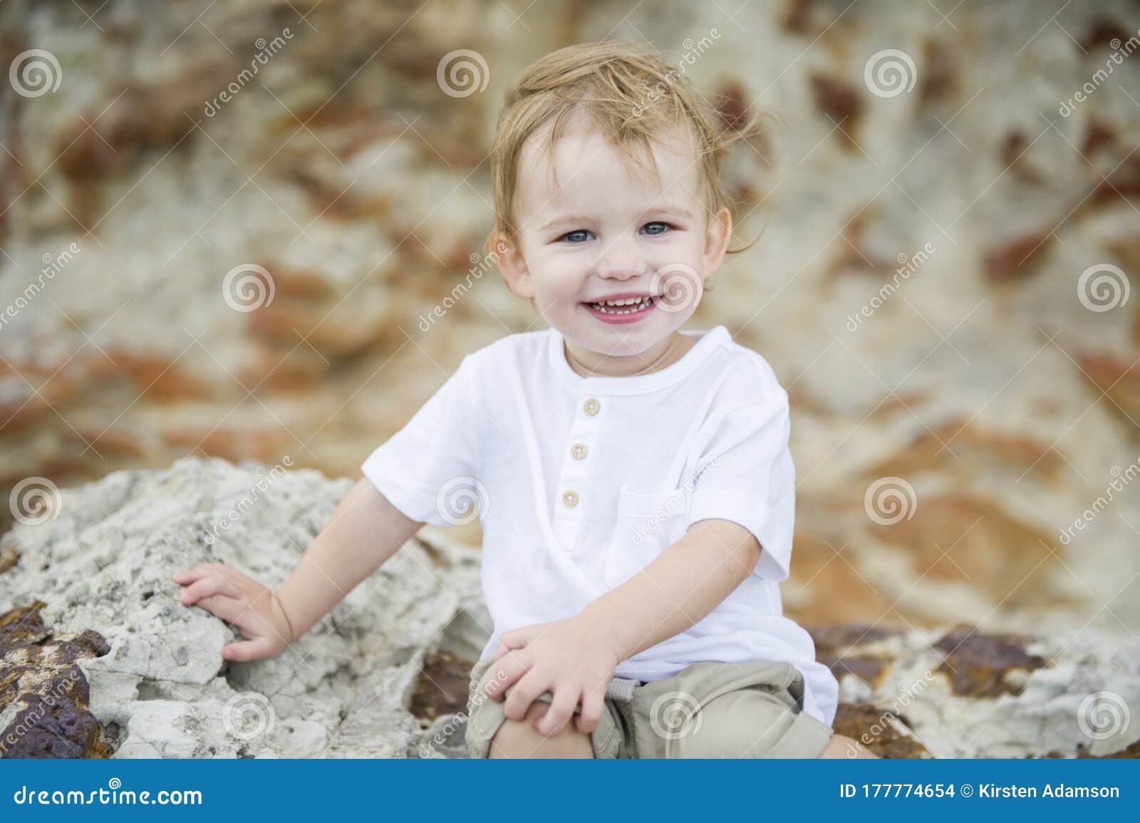 Young boy playing on rocks stock photo. Image of engage - 177774654