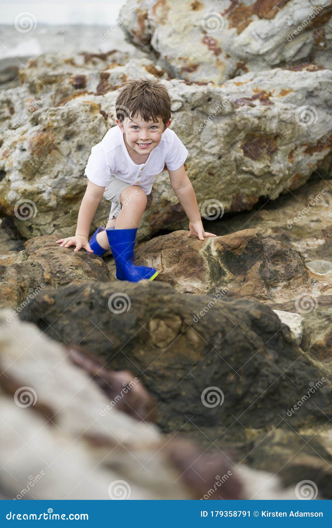 Young boy playing on rocks stock image. Image of cool - 179358791