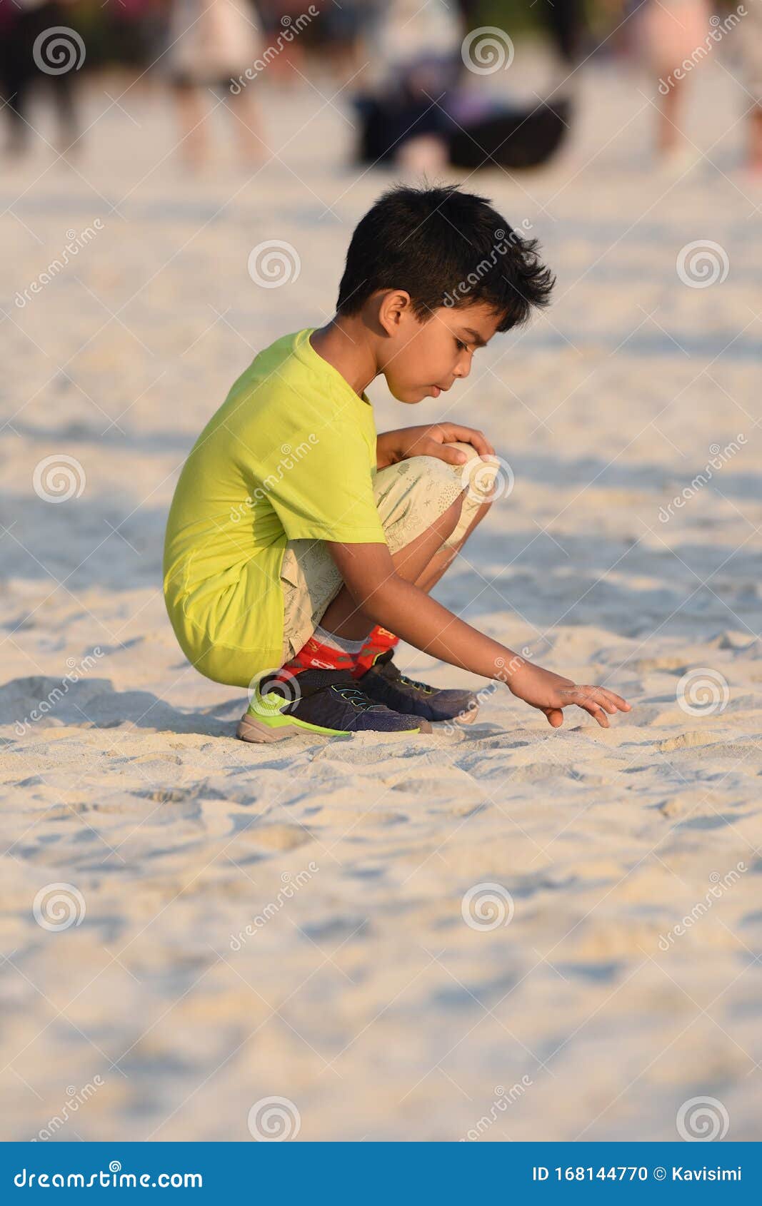 A Young Boy Playing with Sand Stock Photo - Image of casual, little ...