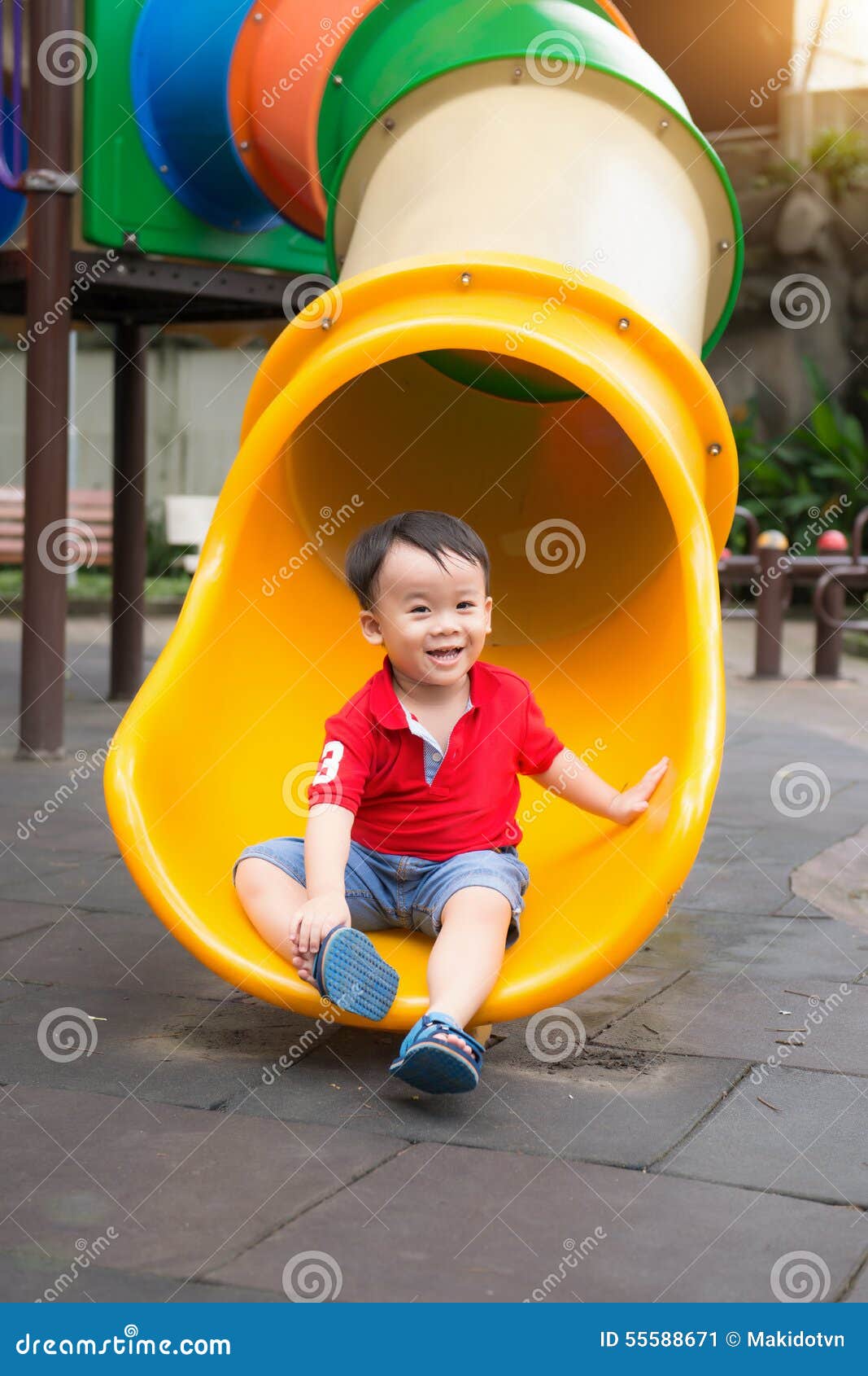 Young Boy Playing on Slide in Playground Stock Image - Image of motion ...