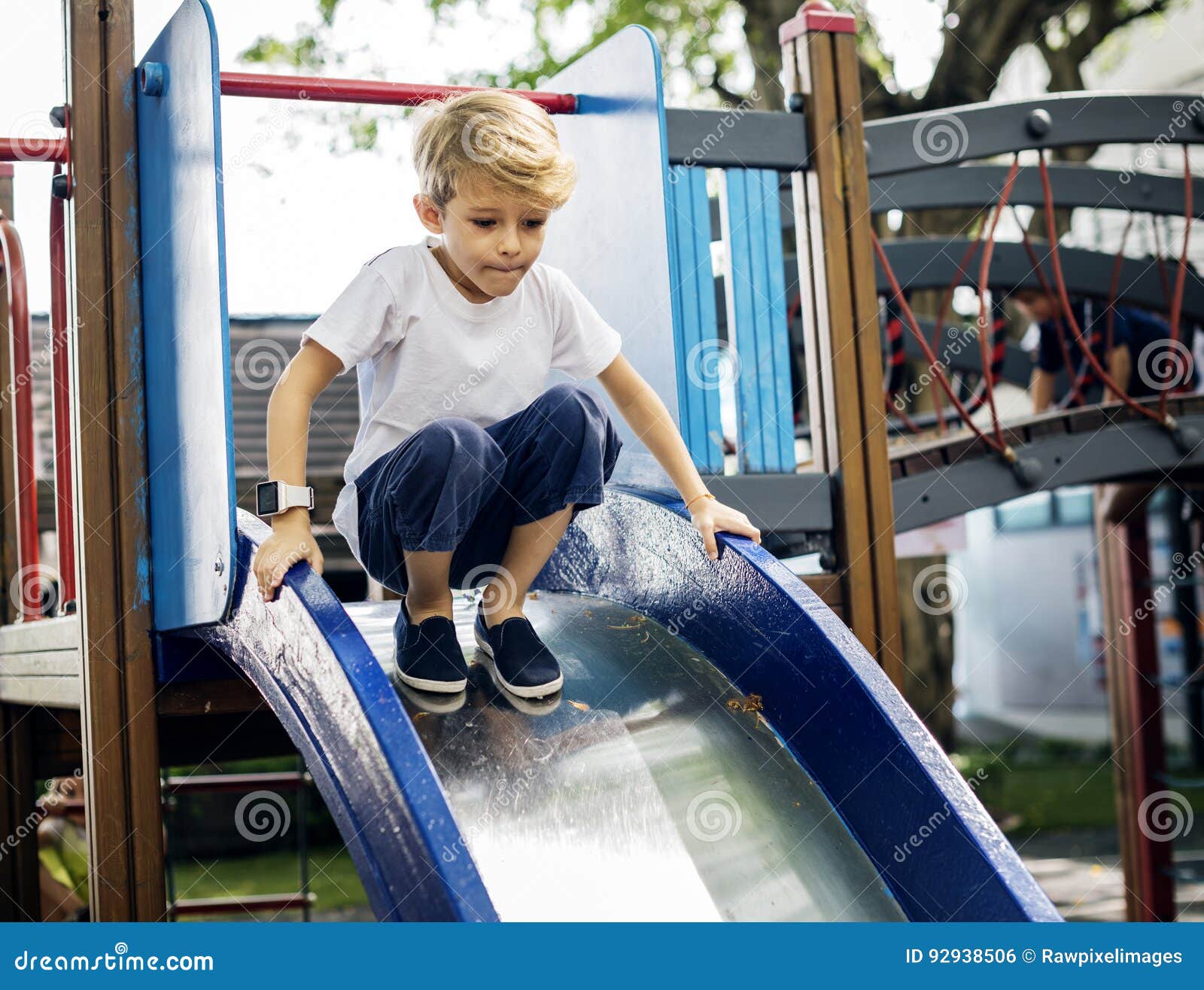 Young Boy Playing Slide in Playground Stock Photo - Image of casual ...