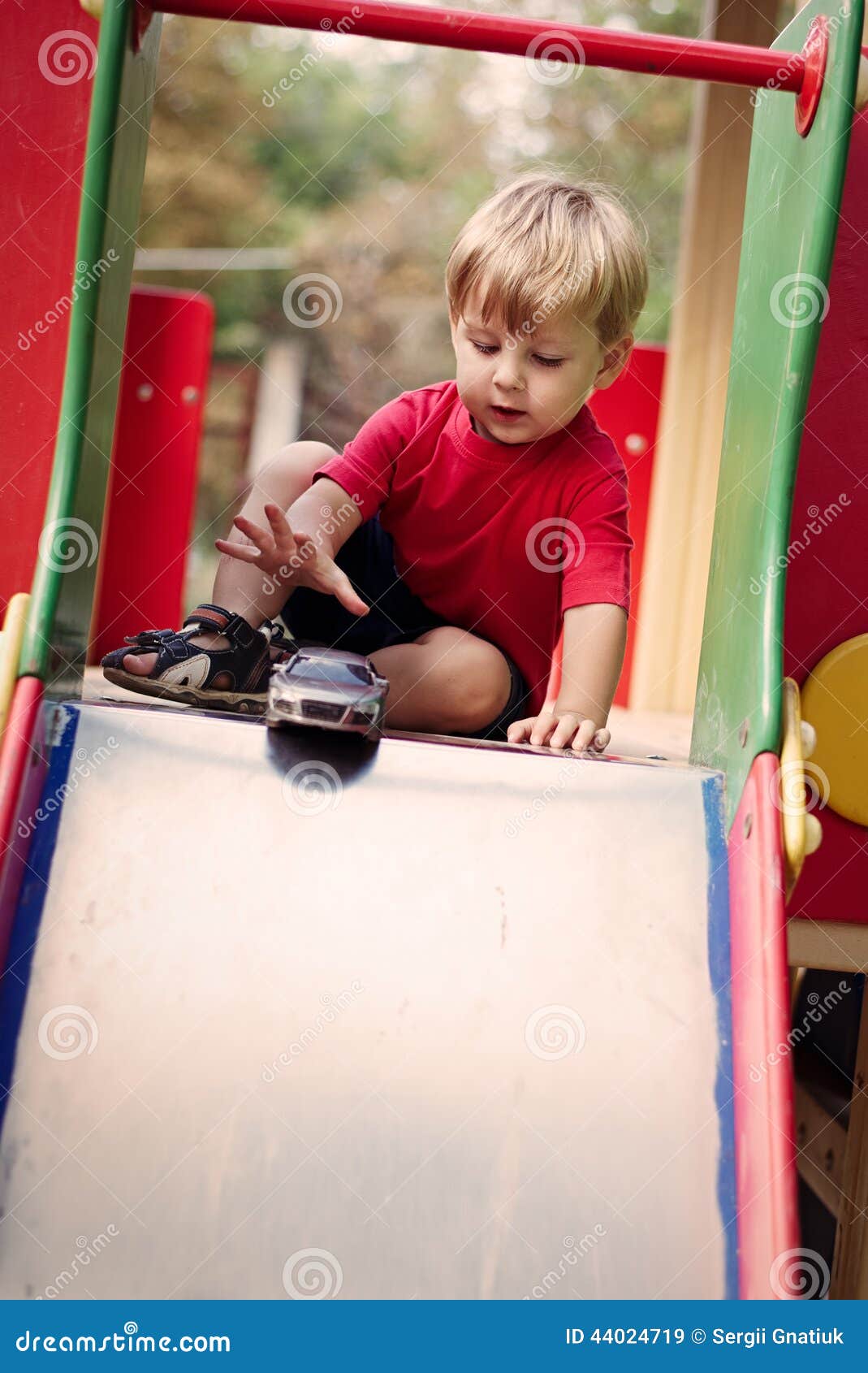 Young Boy Playing with Toy Car on Slide Stock Image - Image of garden ...