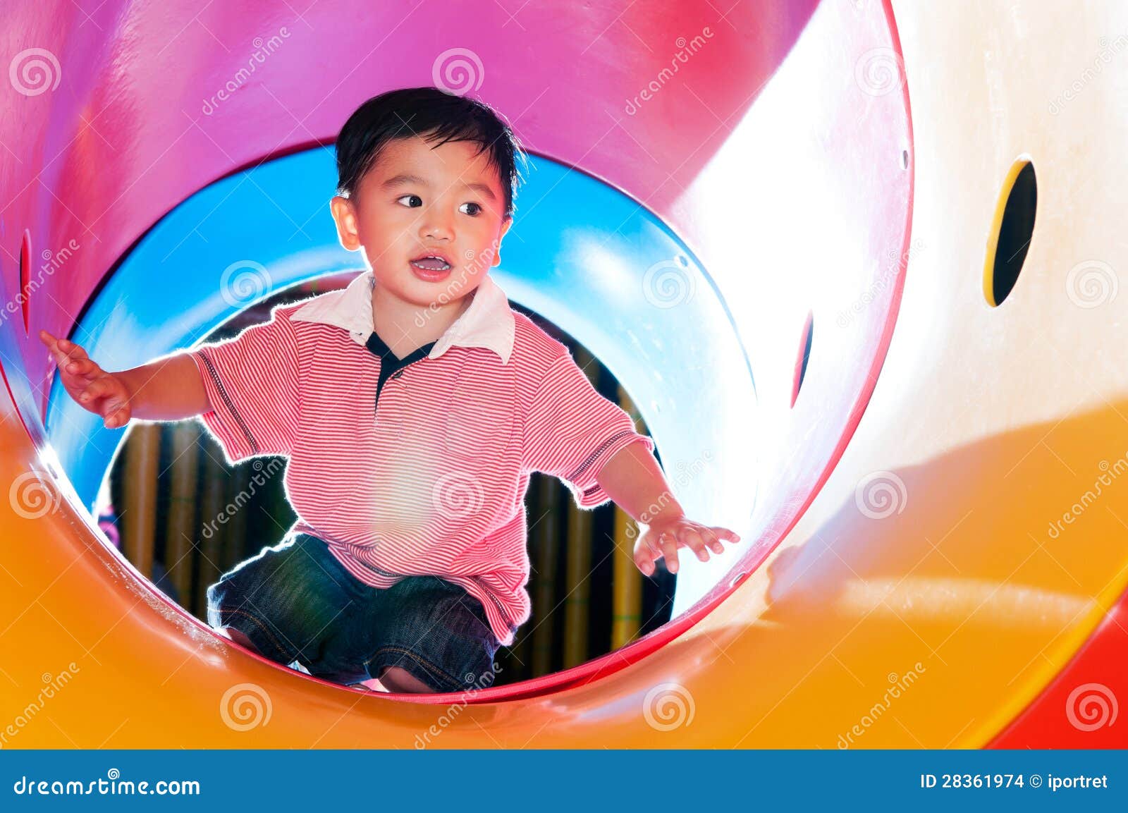 Young Boy Playing in Tube Slide Stock Photo - Image of happy, cheerful ...