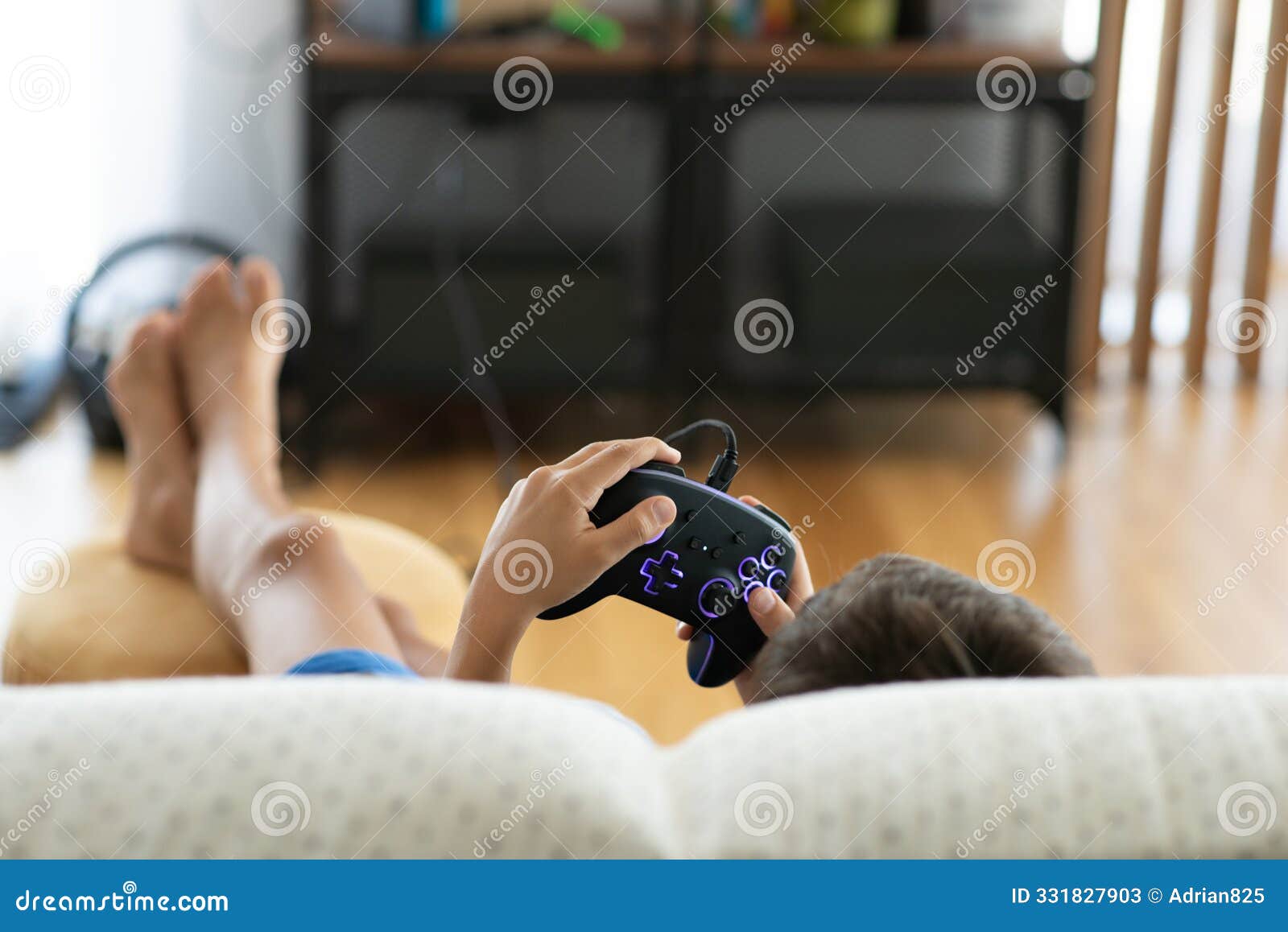 Young Boy Playing Video Game Console Using Joystick or Controller while ...