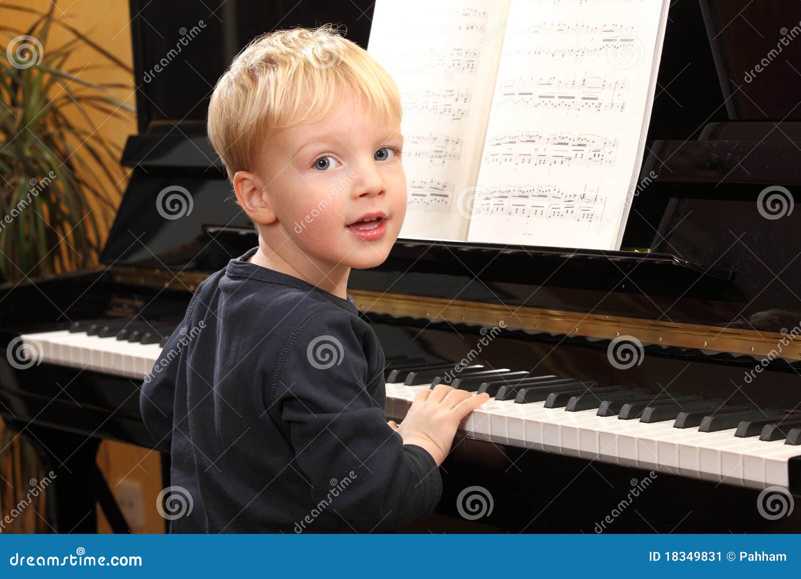 Young boy plays piano stock image. Image of childhood - 18349831
