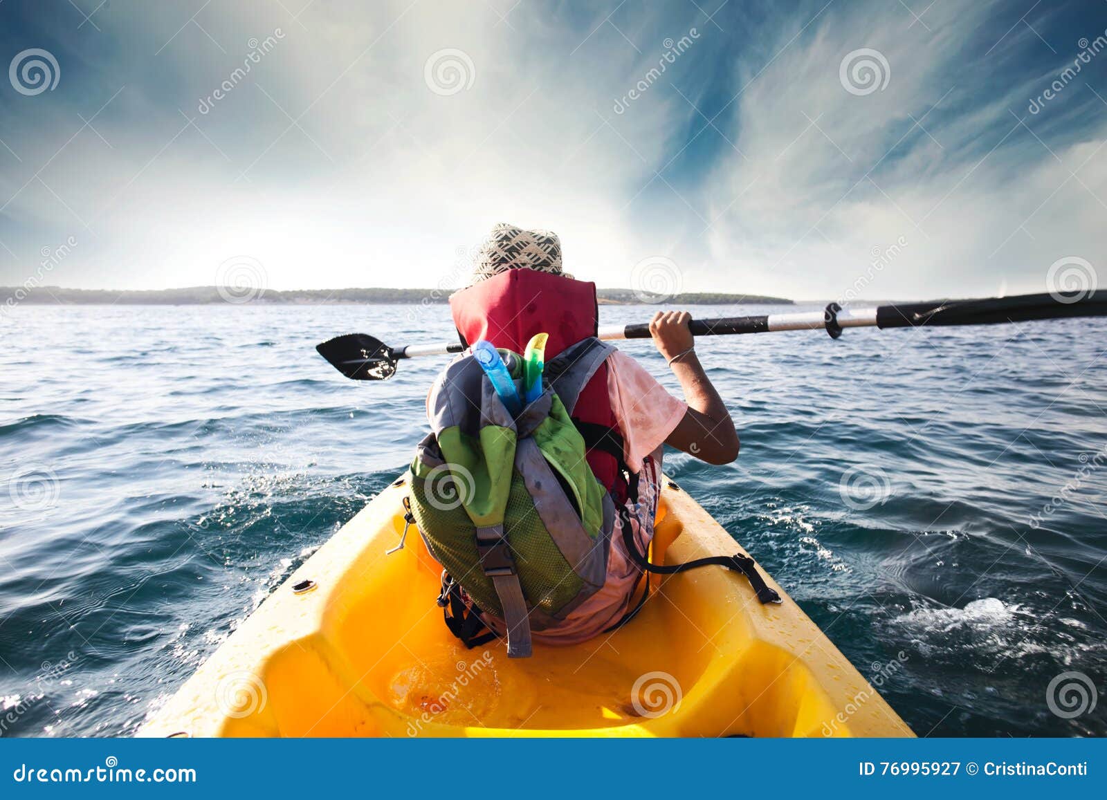 Young Boy Plows through the Waters of the Sea with His Canoe Stock ...