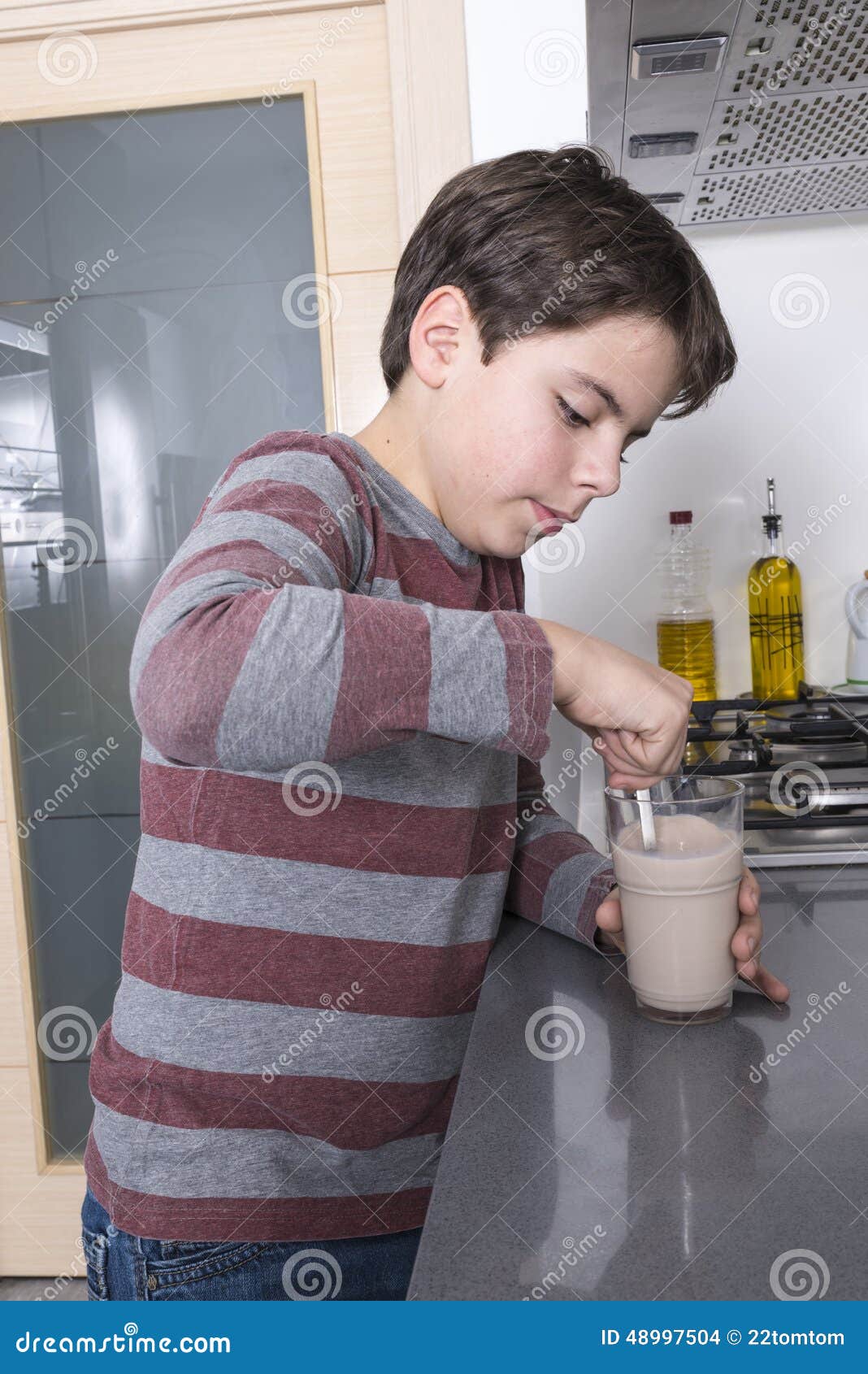 Young Boy Preparing a Glass of Milk Stock Photo - Image of indoors ...