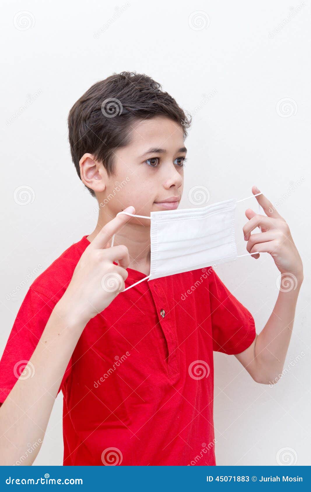 Young Boy Putting on a Face Mask To Stop Spread of Germs Stock Image ...