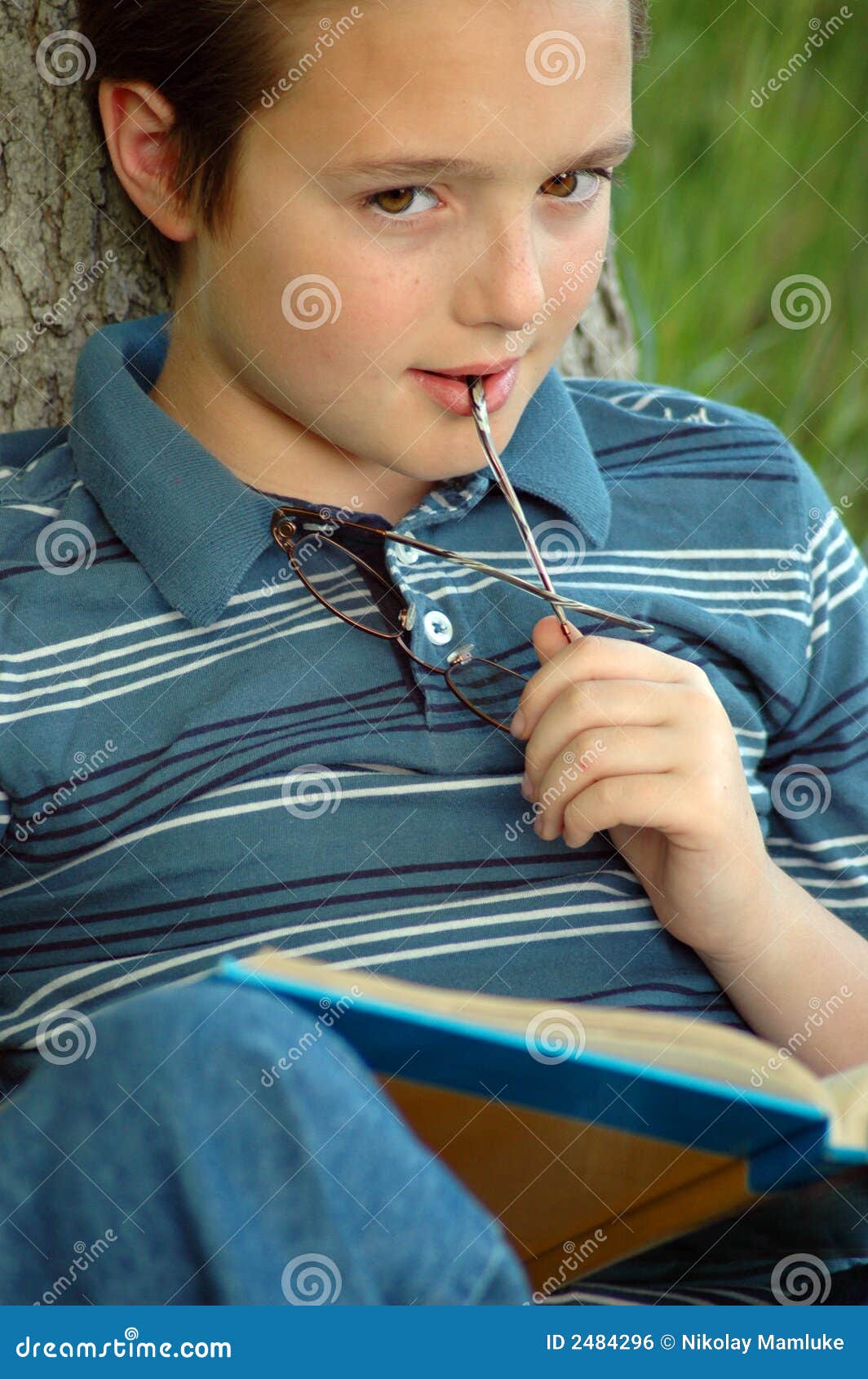 Young boy reading a book stock photo. Image of grass, male - 2484296