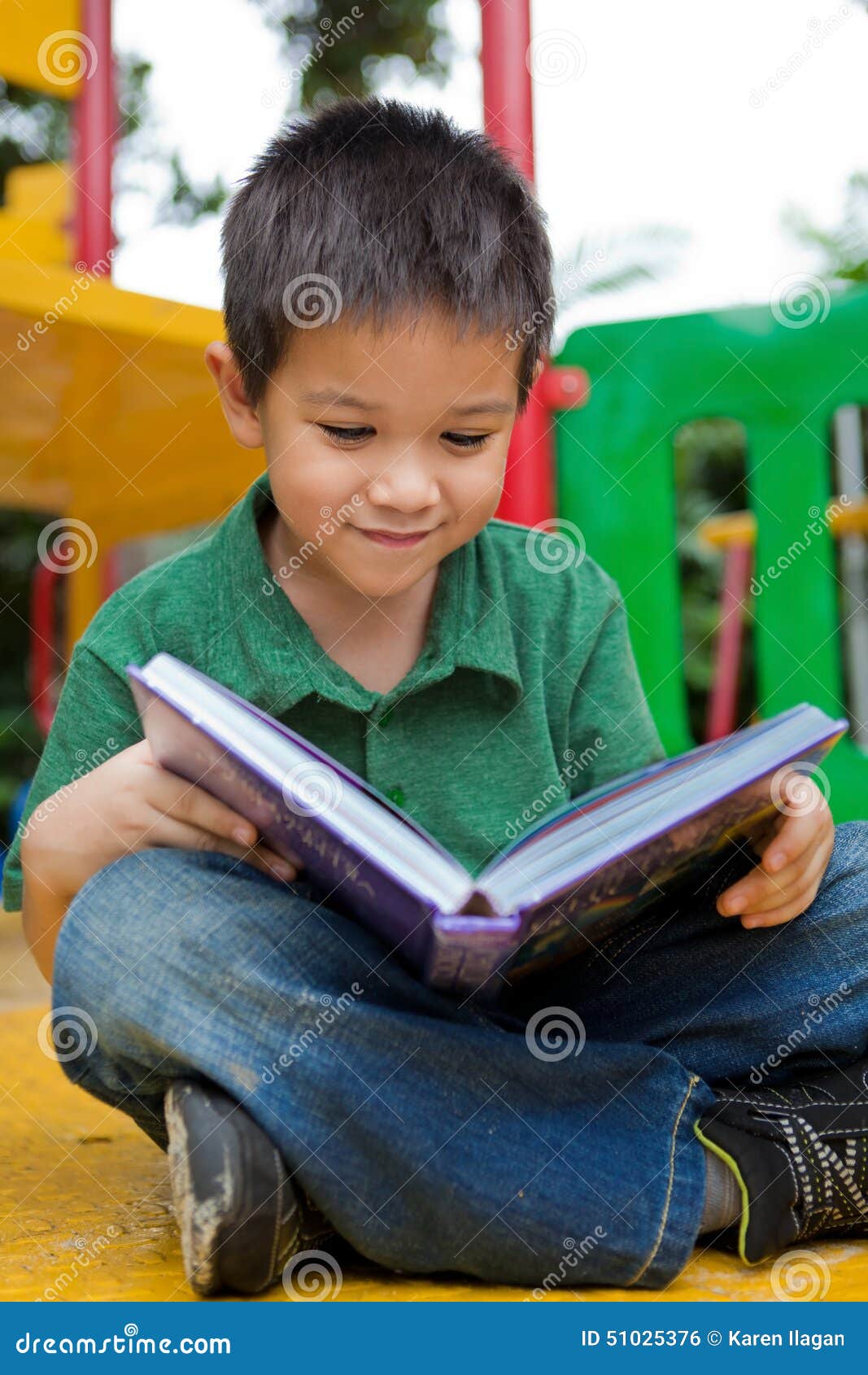 Young Boy Reading Book in a Playground Stock Photo - Image of blue ...