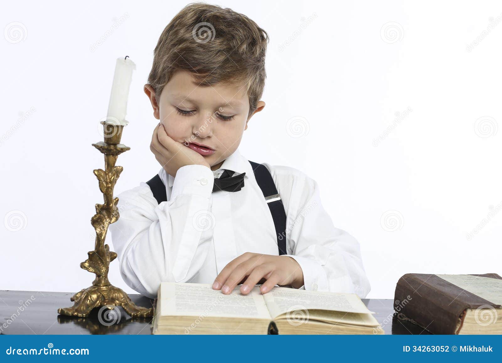 Young boy reads a big book stock photo. Image of school - 34263052