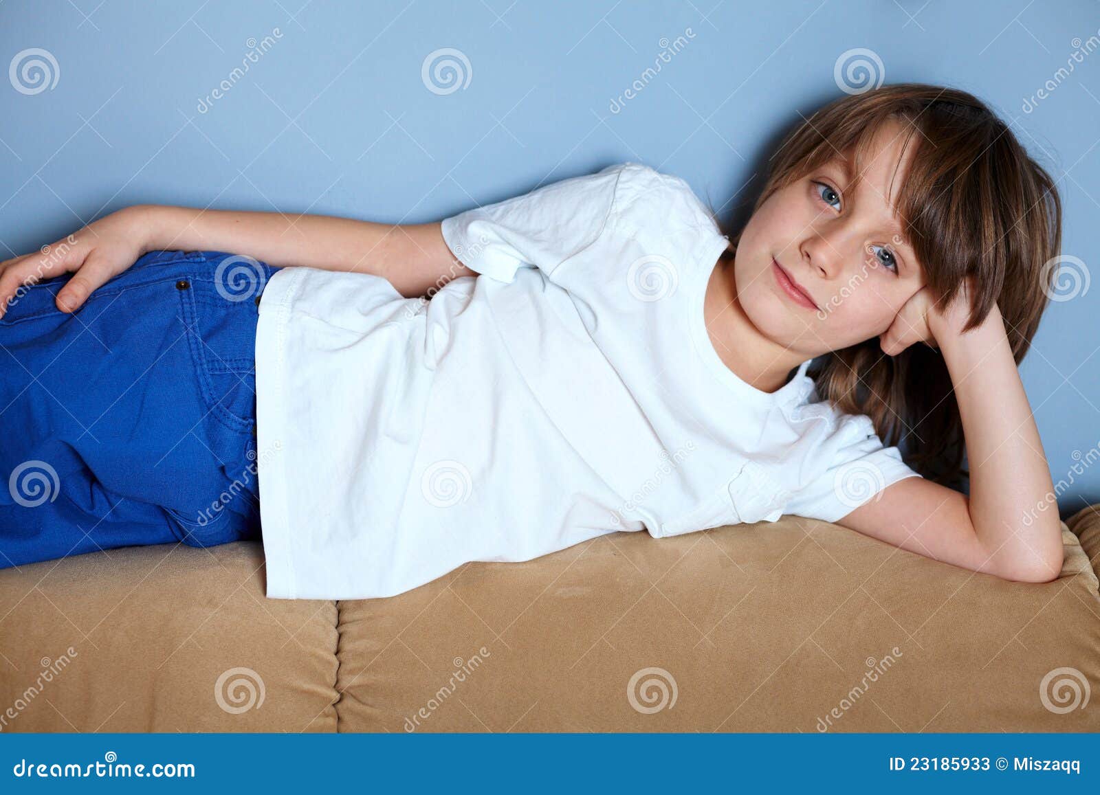 Young Boy Relaxing On The Sofa Stock Photos - Image: 23185933