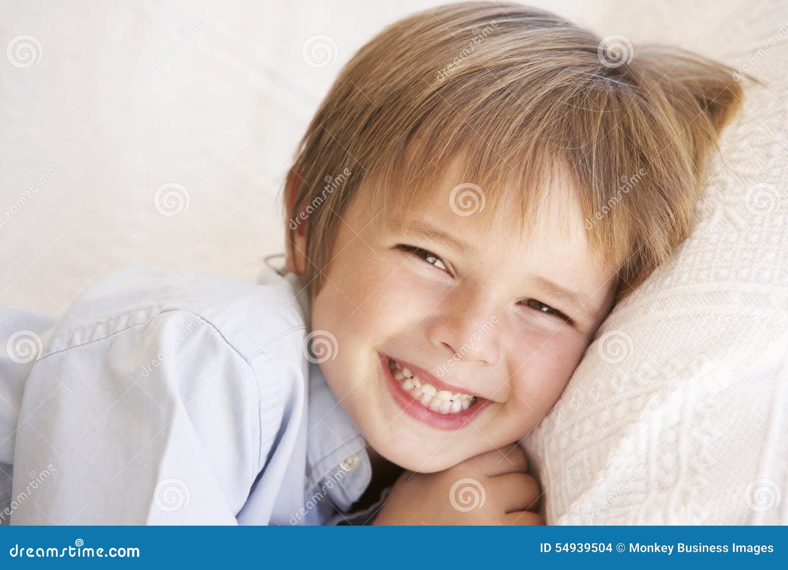 Young Boy Relaxing on Sofa at Home Stock Photo - Image of person ...
