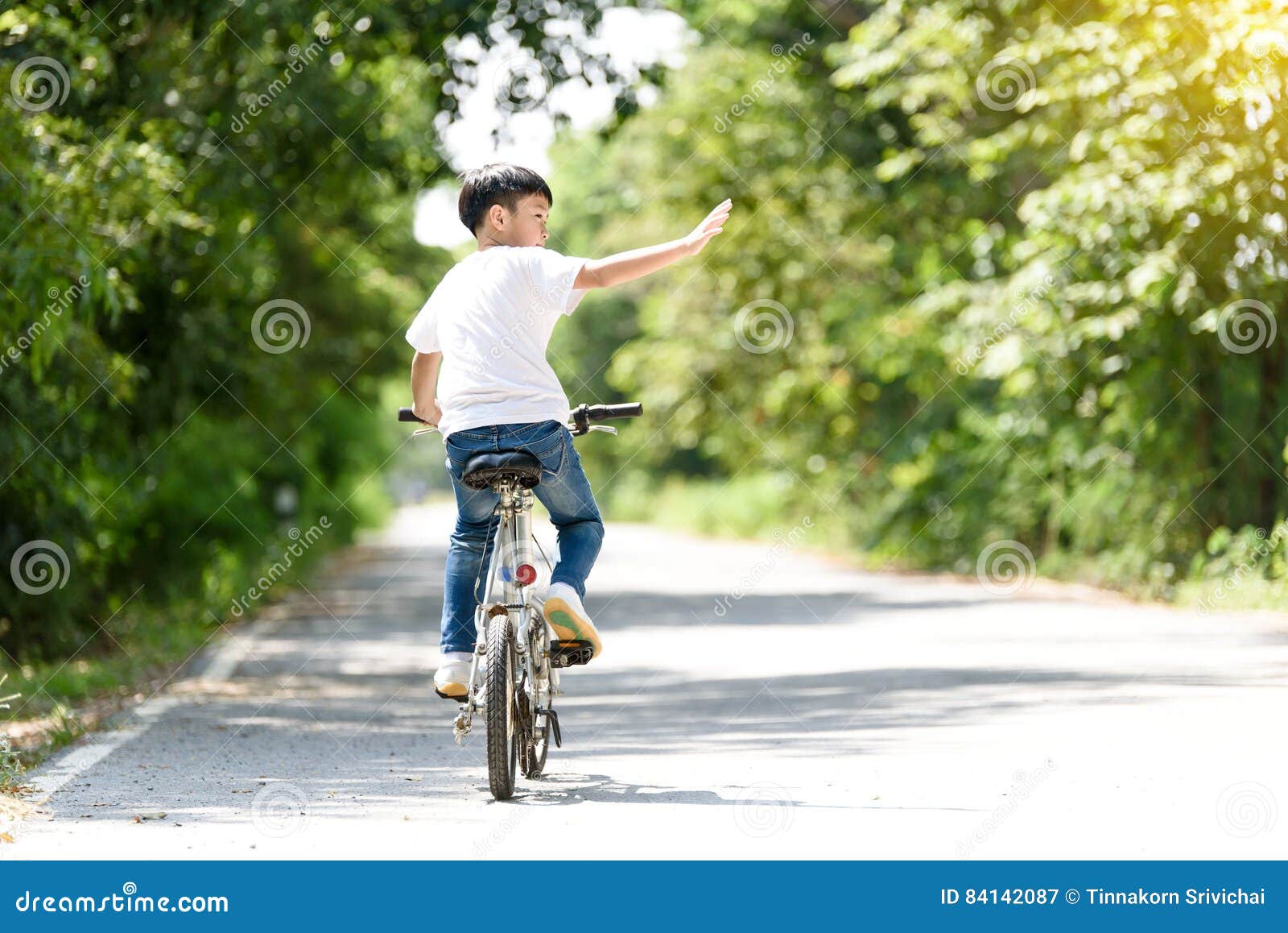 Young boy ride bicycle stock image. Image of grass, male - 84142087