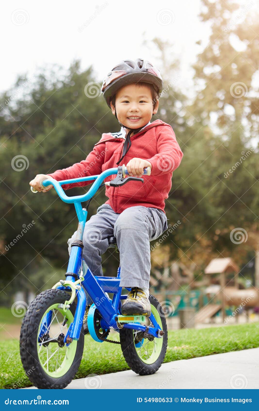 Young Boy Riding Bike in Park Stock Image - Image of portrait, outdoors ...
