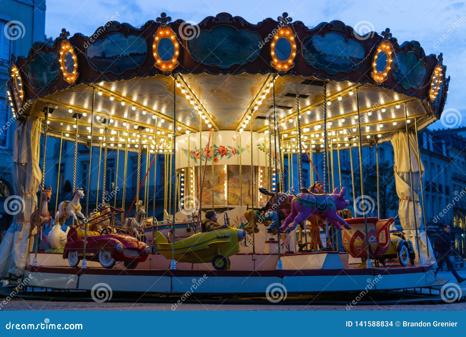 Young Boy Riding Old Carousel at Night with Bright Lights Editorial ...