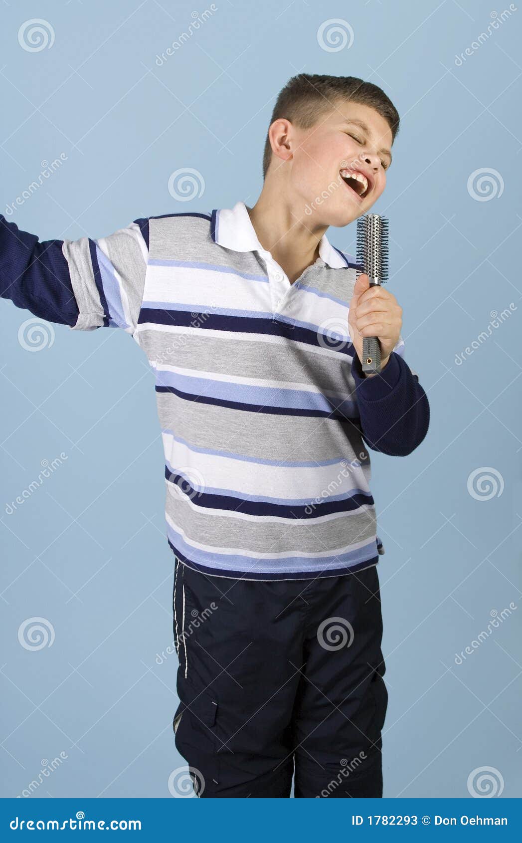 Young Boy Rock Star Wannabe Stock Image - Image of child, microphone ...