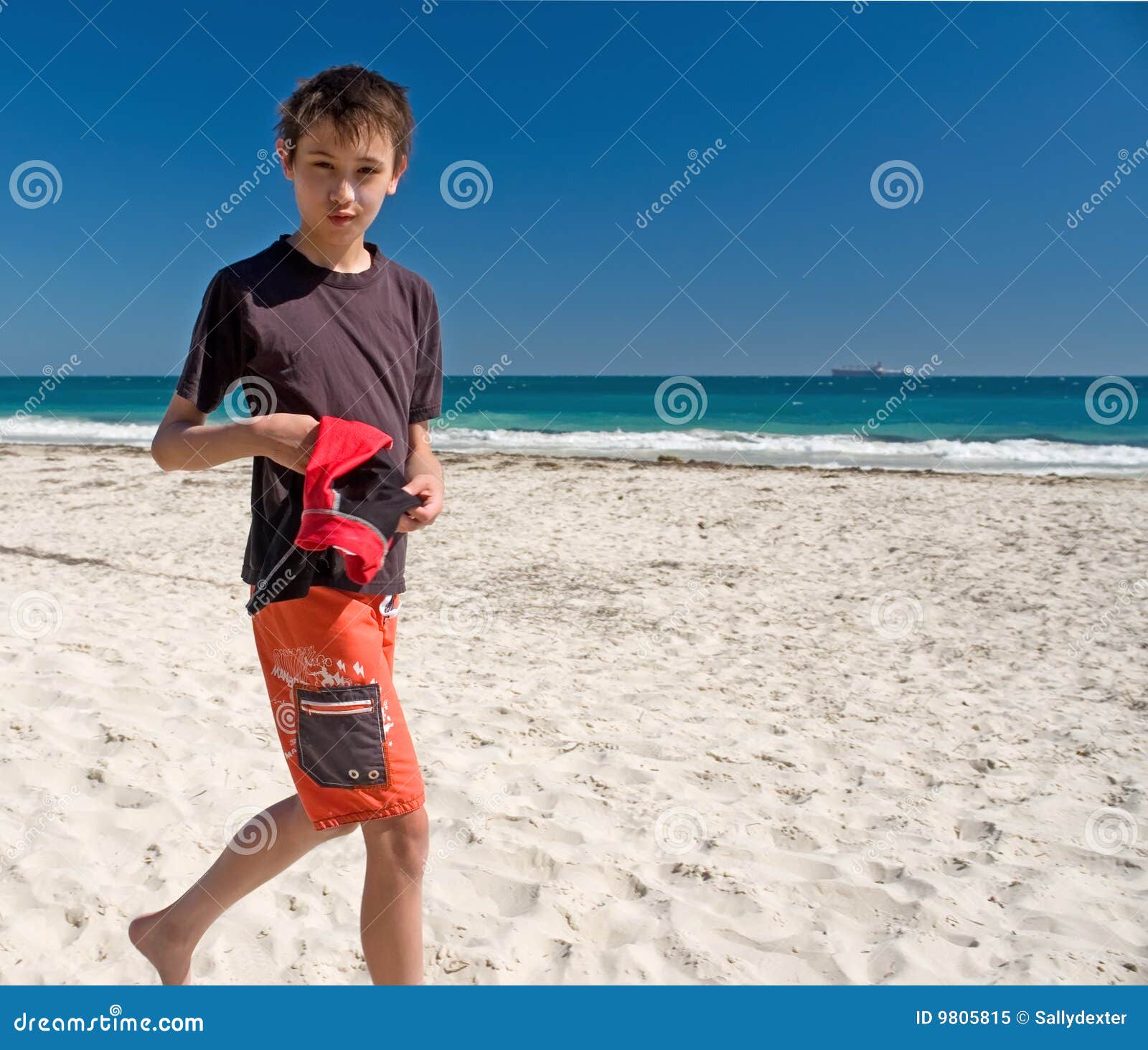 Young boy running on beach stock image. Image of teen - 9805815