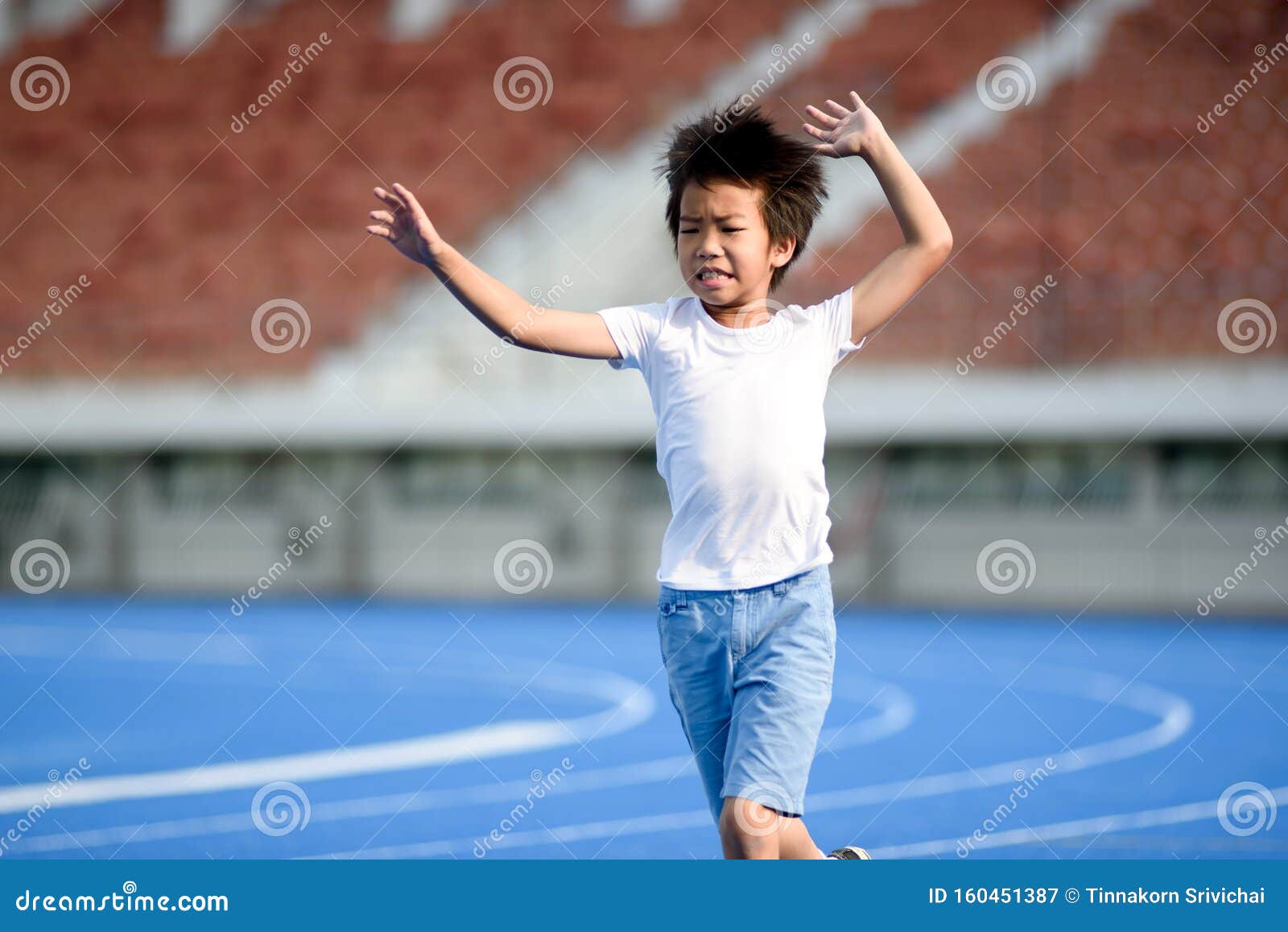 Young Boy Running on Blue Track Stock Image - Image of kids, runner ...