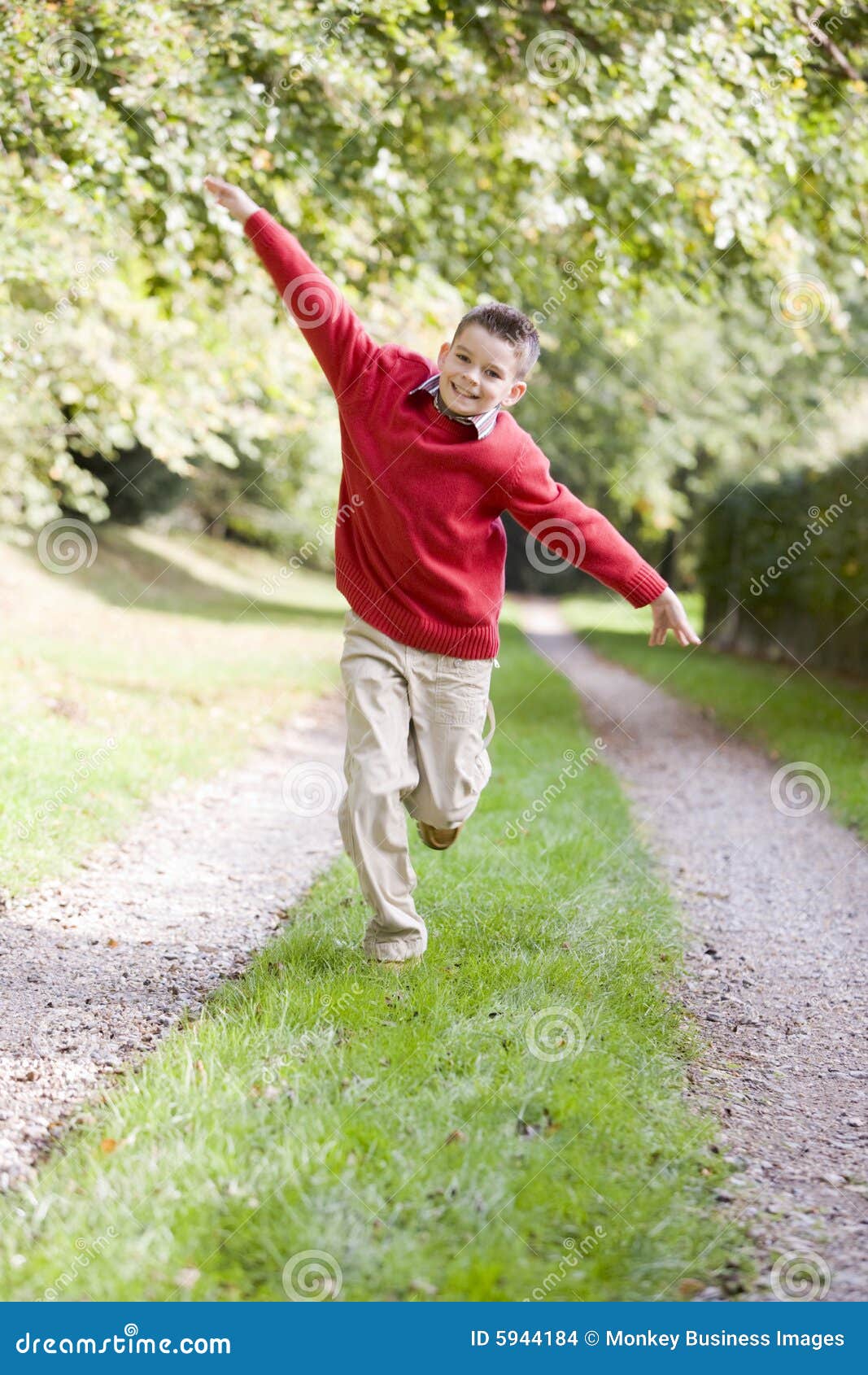Young Boy Running on a Path Outdoors Smiling Stock Photo - Image of ...