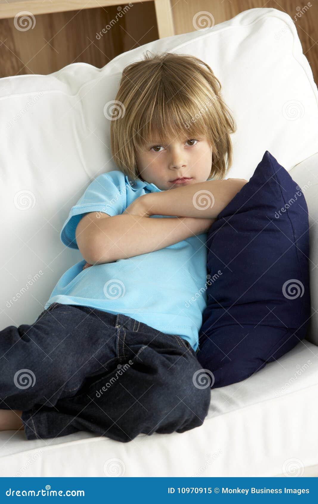 Young Boy Sat on Sofa at Home Stock Image - Image of dress, colour ...