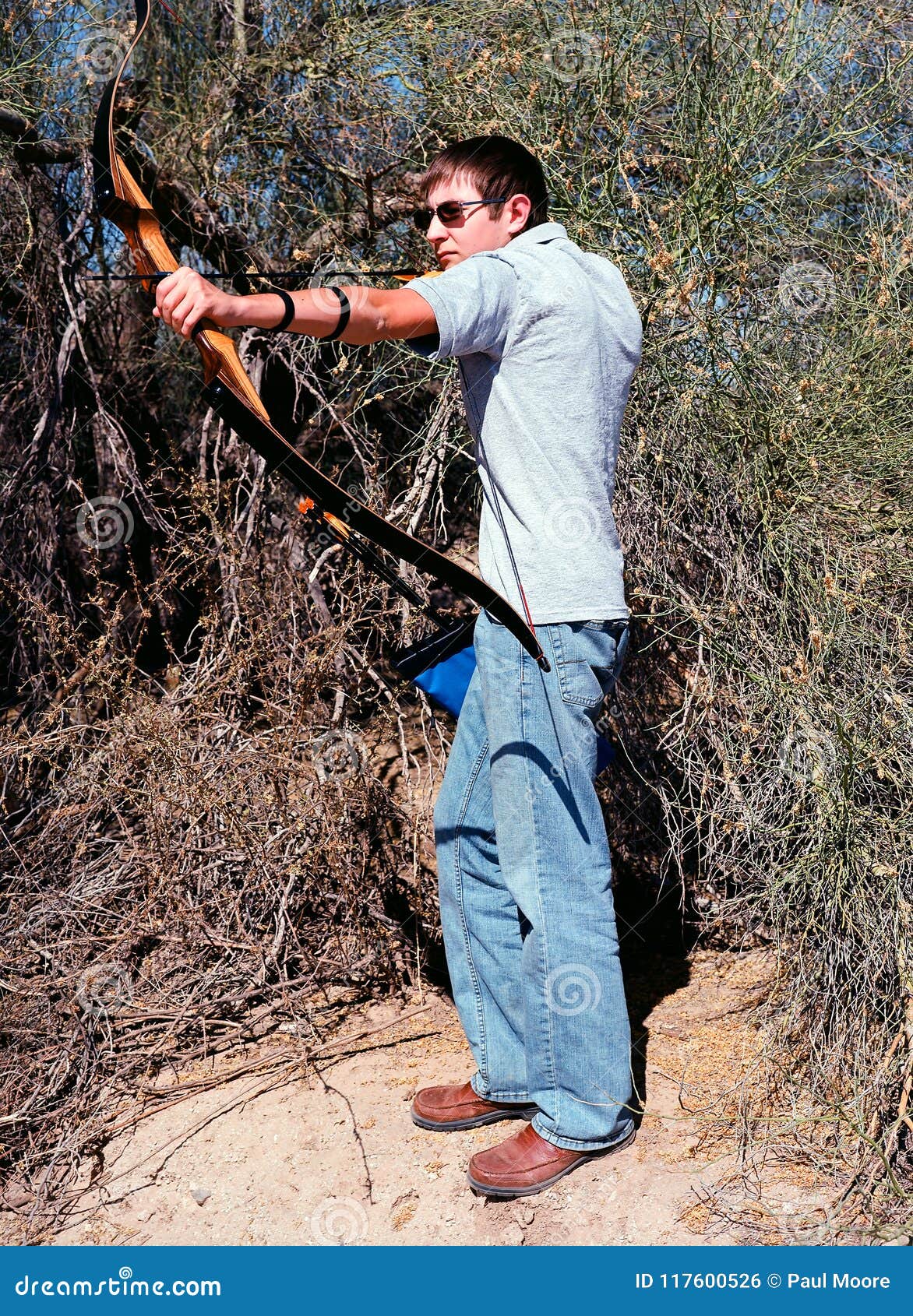 Young Boy Shooting a Bow and Arrow Stock Photo - Image of outdoor ...