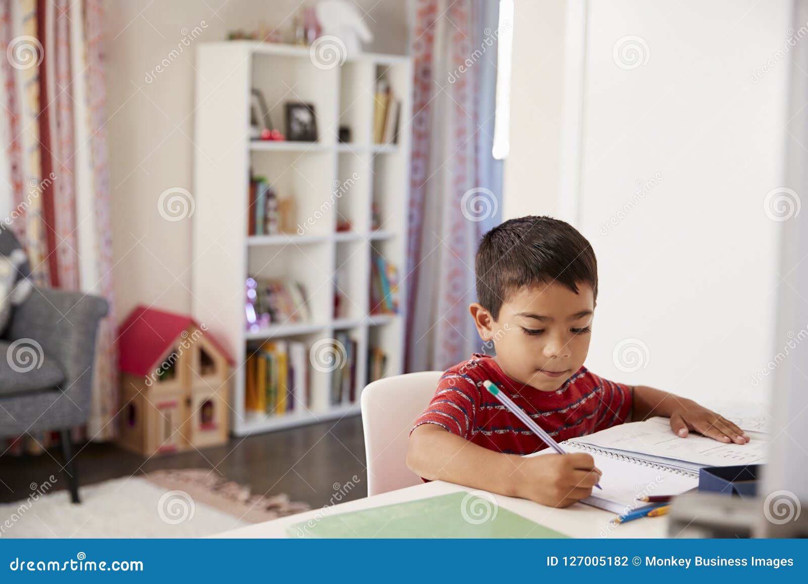 Young Boy Sitting at Desk in Bedroom Doing Homework Stock Photo - Image ...