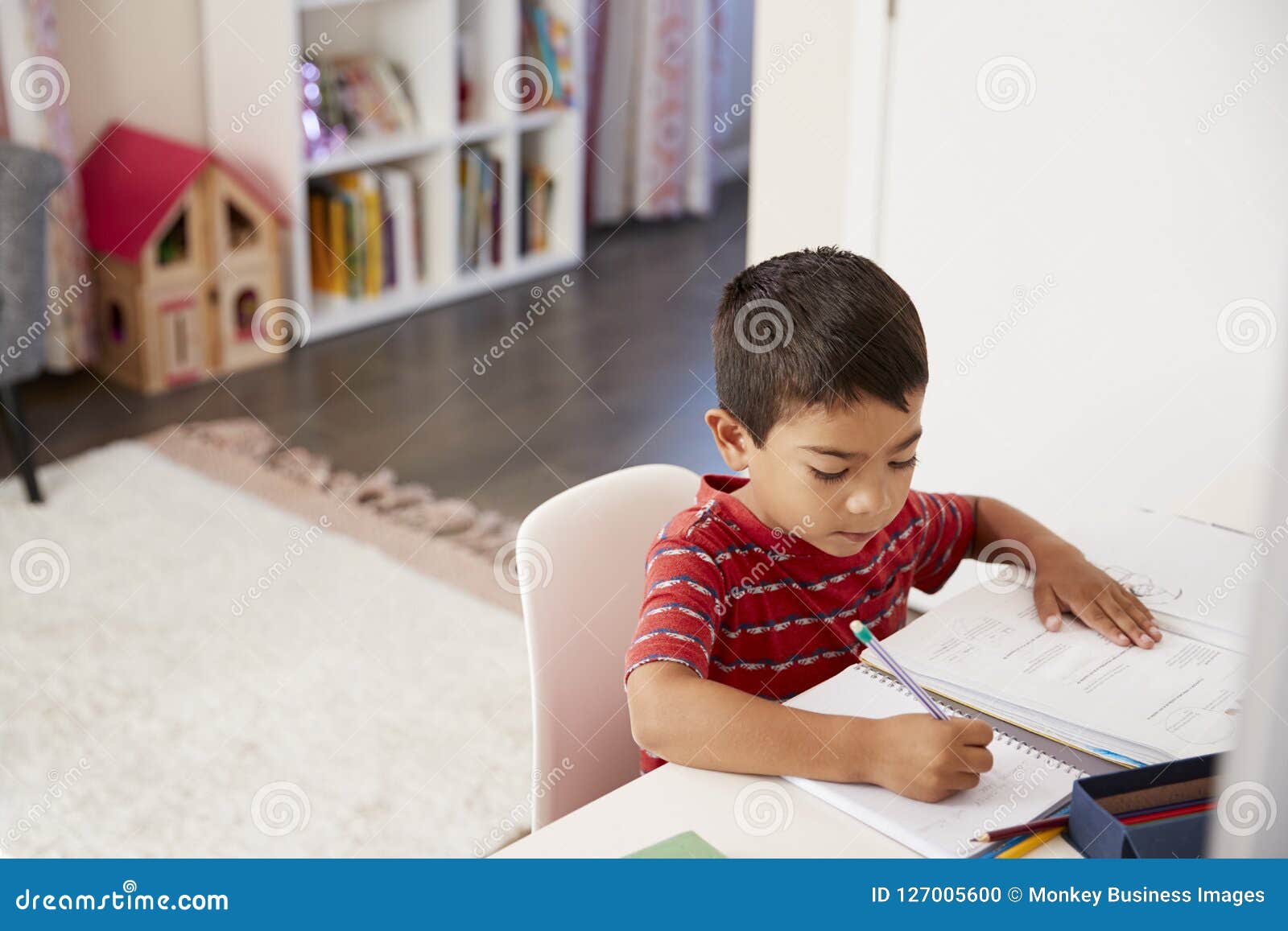 Young Boy Sitting at Desk in Bedroom Doing Homework Stock Photo - Image ...