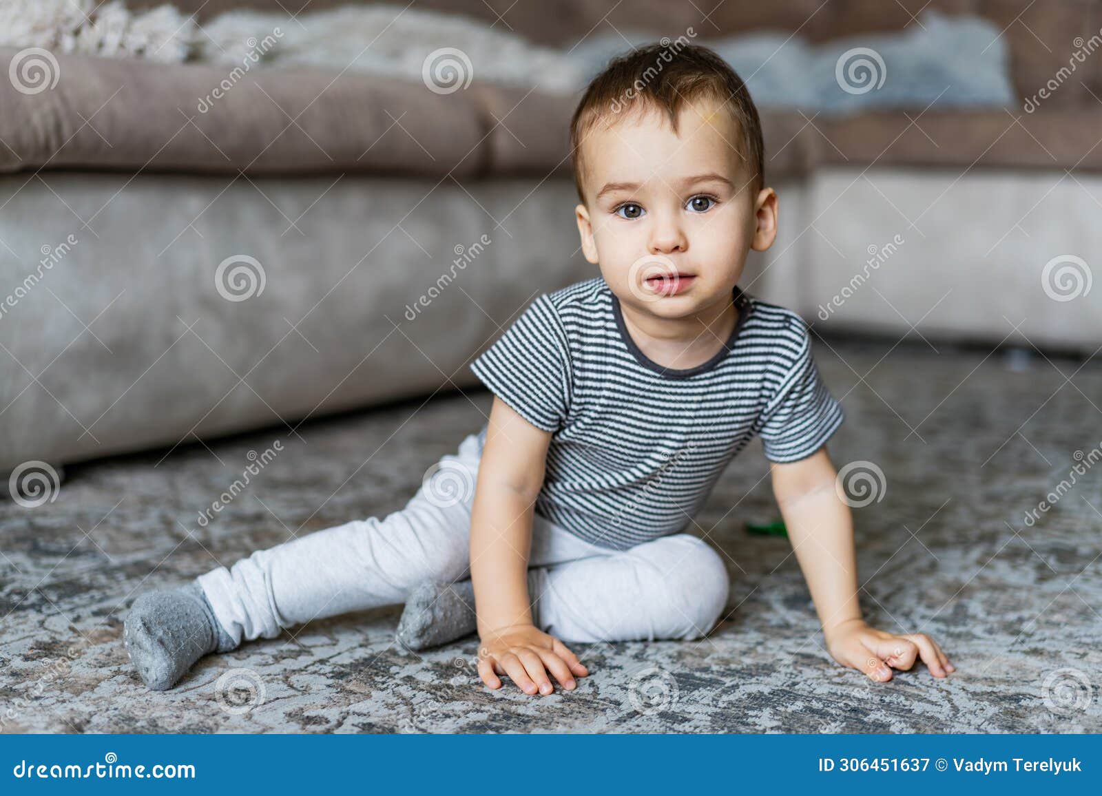 Young Boy Sitting on the Floor. a Little Boy that is Sitting on the ...