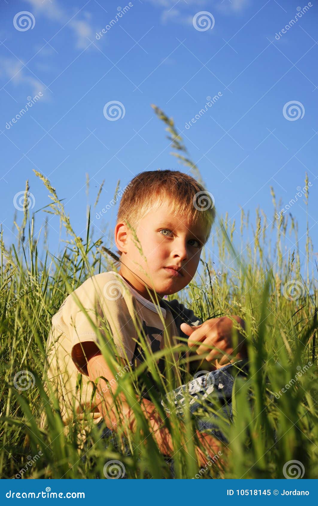 Young Boy Sitting on Green Grass Stock Image - Image of parenthood ...