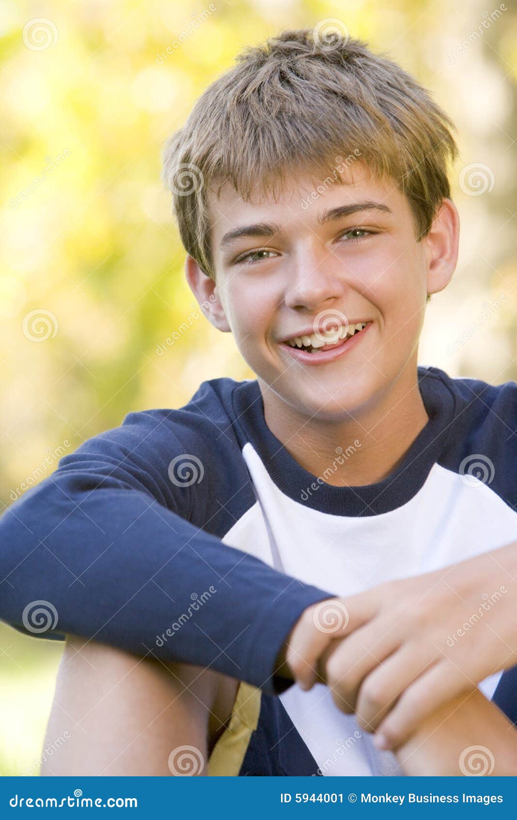 Young Boy Sitting Outdoors Smiling Stock Image - Image: 5944001