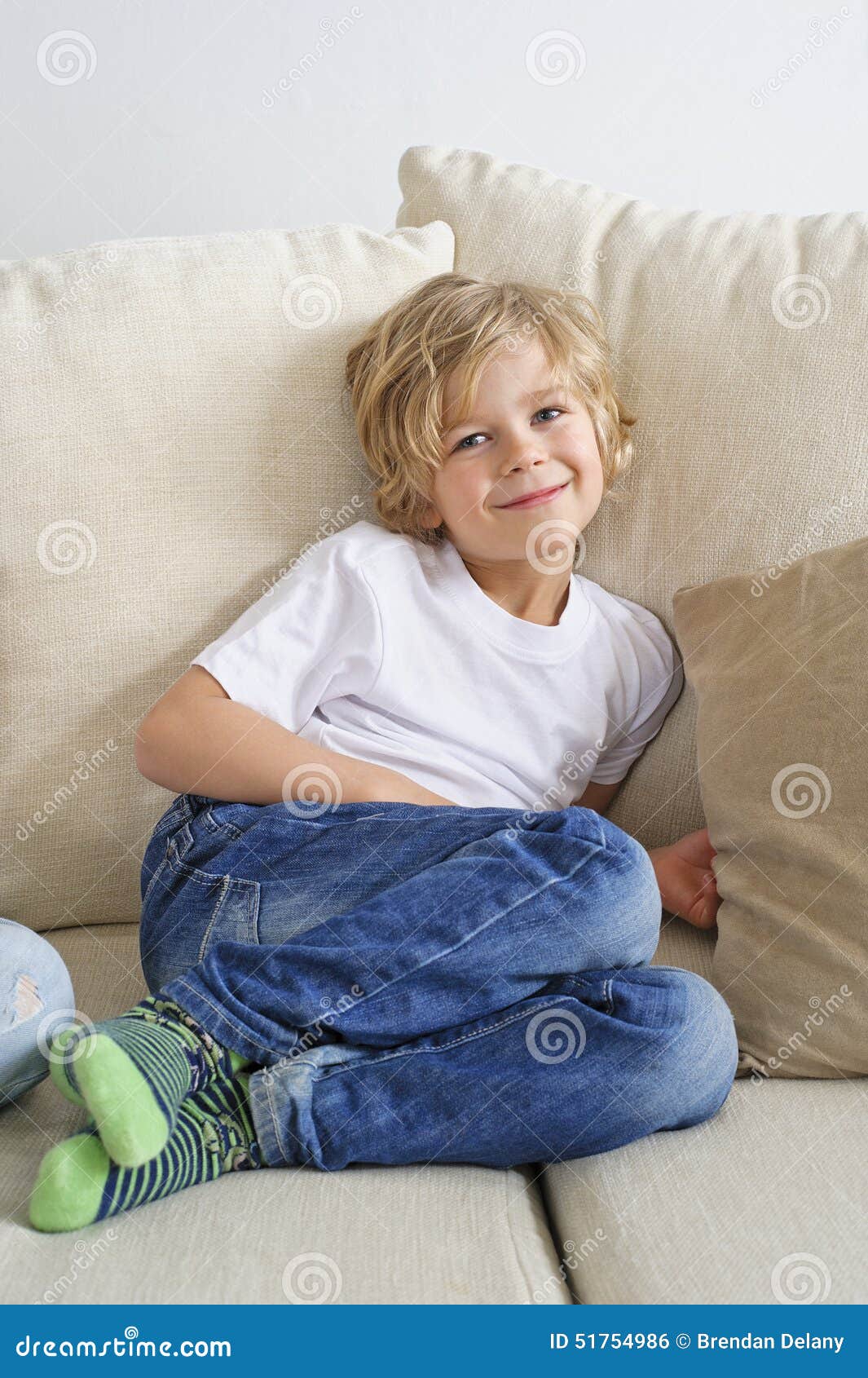 Young boy sitting on sofa stock photo. Image of happy - 51754986