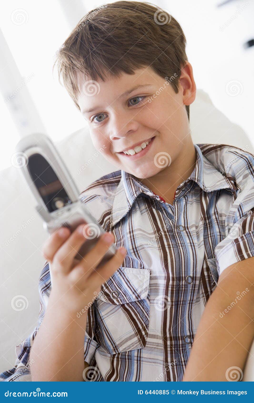 Young Boy Sitting on a Sofa Texting Stock Image - Image of mobile ...
